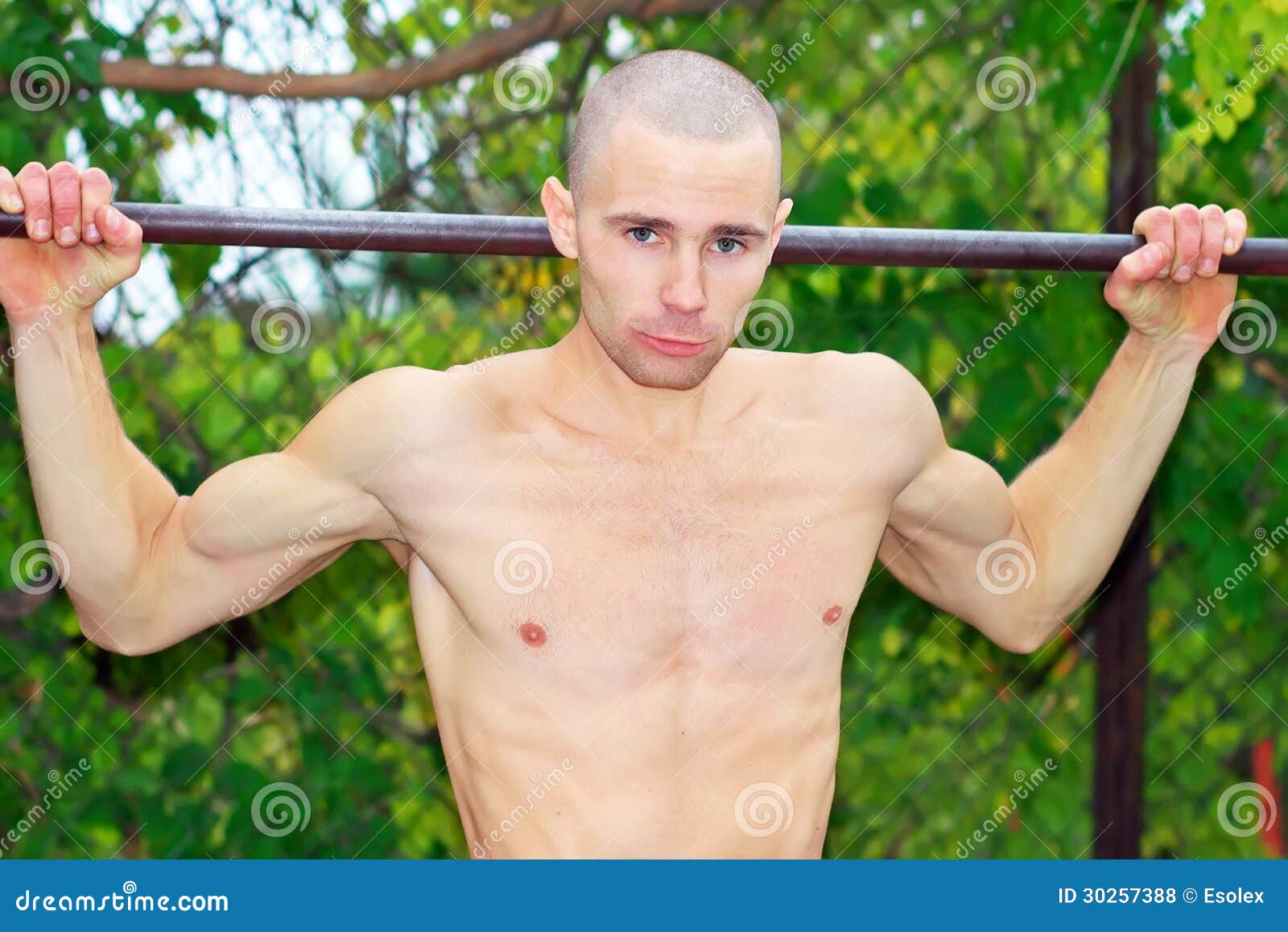 Strong man doing pull-ups stock photo. Image of looking - 30257388