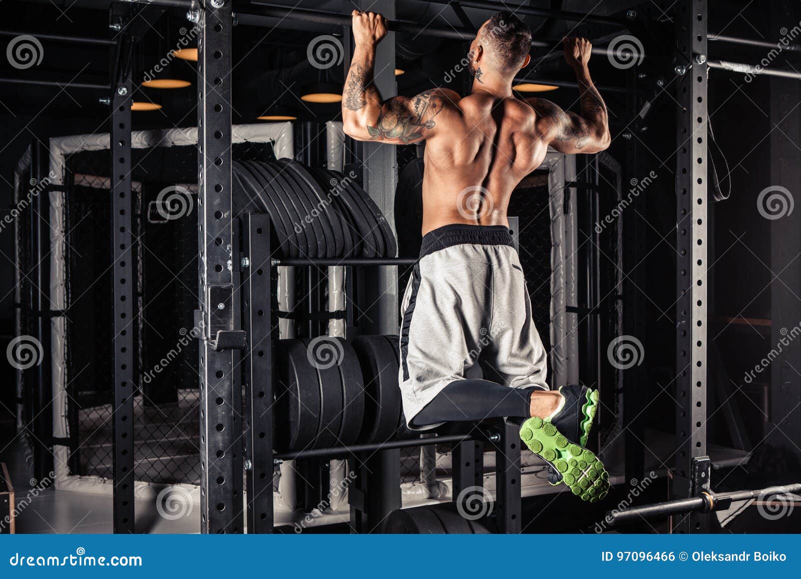 Strong man doing pull ups stock photo. Image of club - 97096466