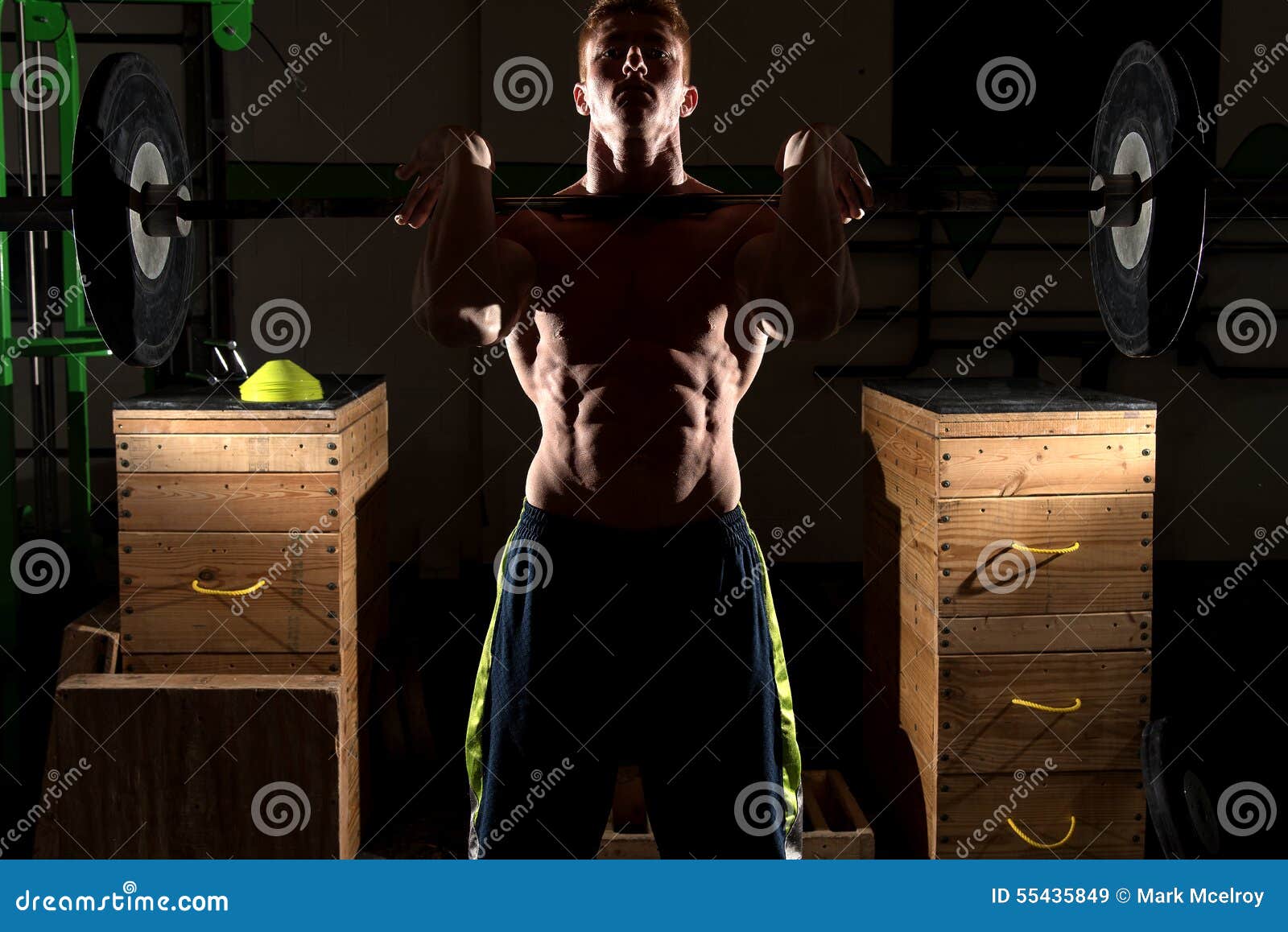 Strong Man Exercising in Dramatic Light Stock Image - Image of ...