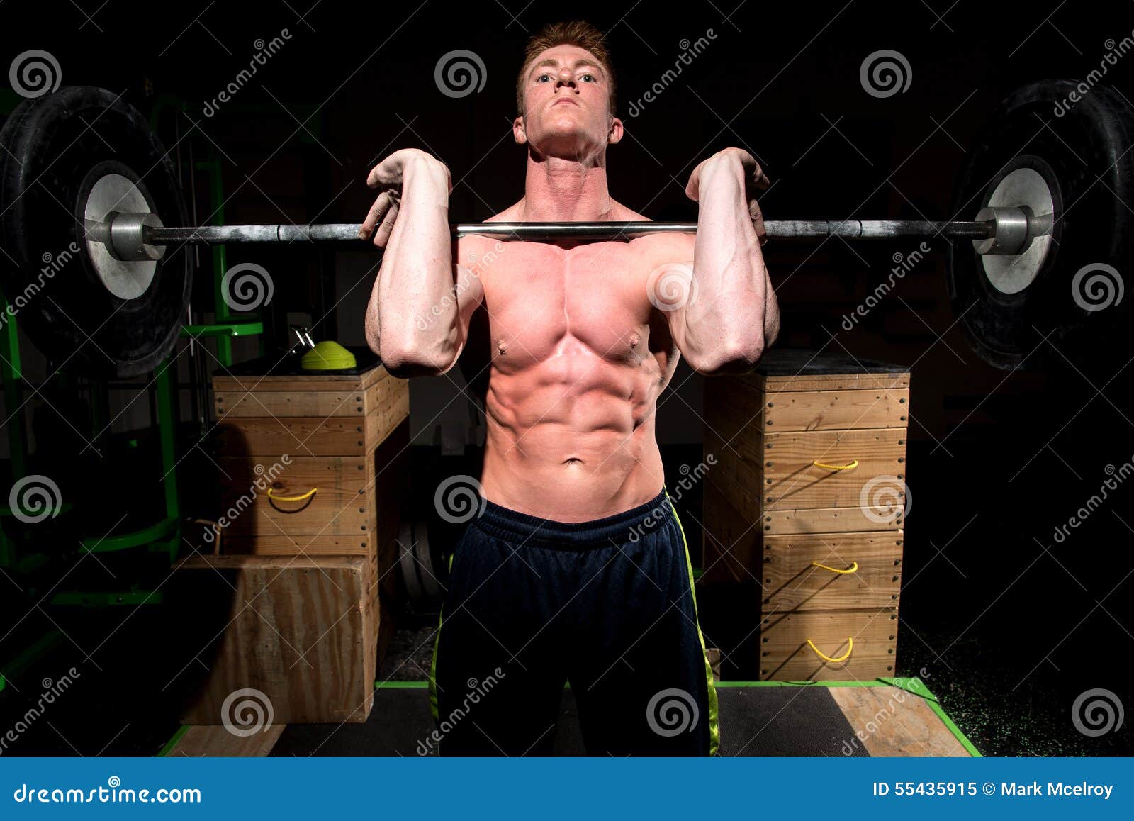 Strong Man Exercising in Dramatic Light Stock Image - Image of lifting ...