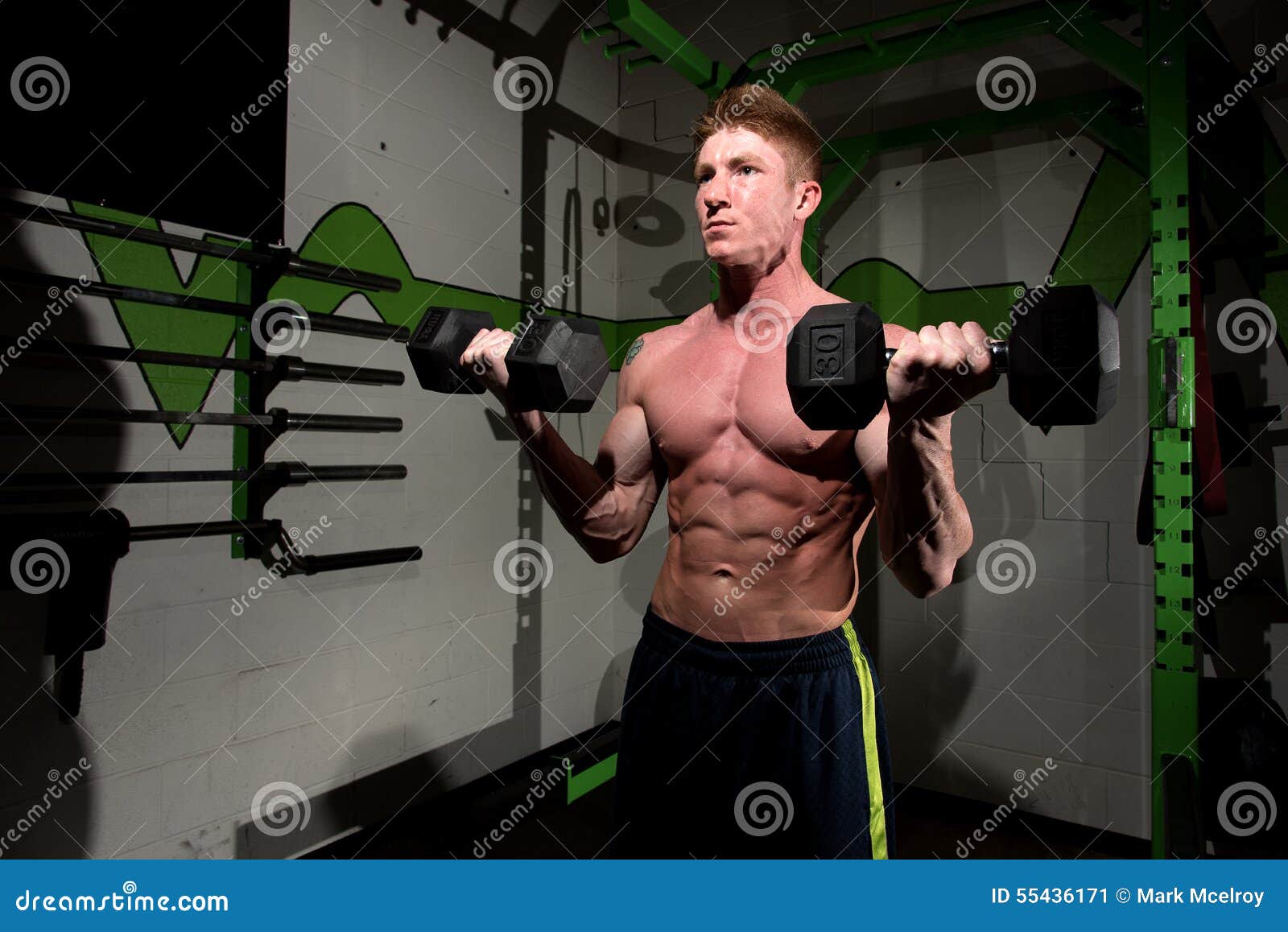 Strong Man Exercising in Dramatic Light Stock Image - Image of ...