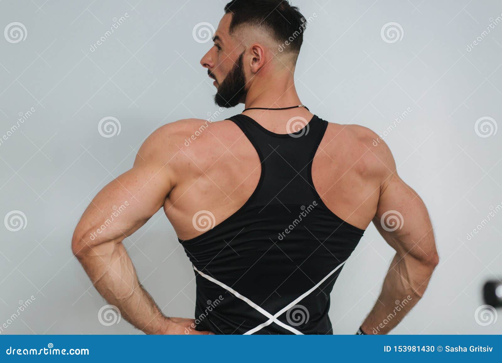 Strong Man Show His Back Muscules on Grey Background Stock Photo ...