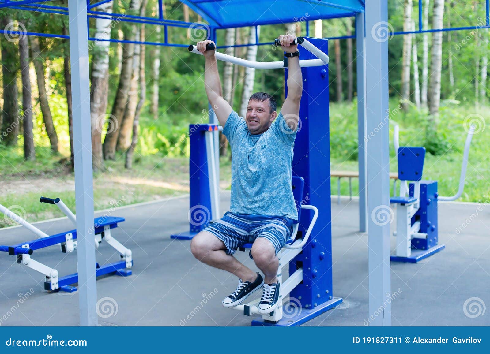 Strong Man on a Simulator in the Park Stock Image - Image of adult ...