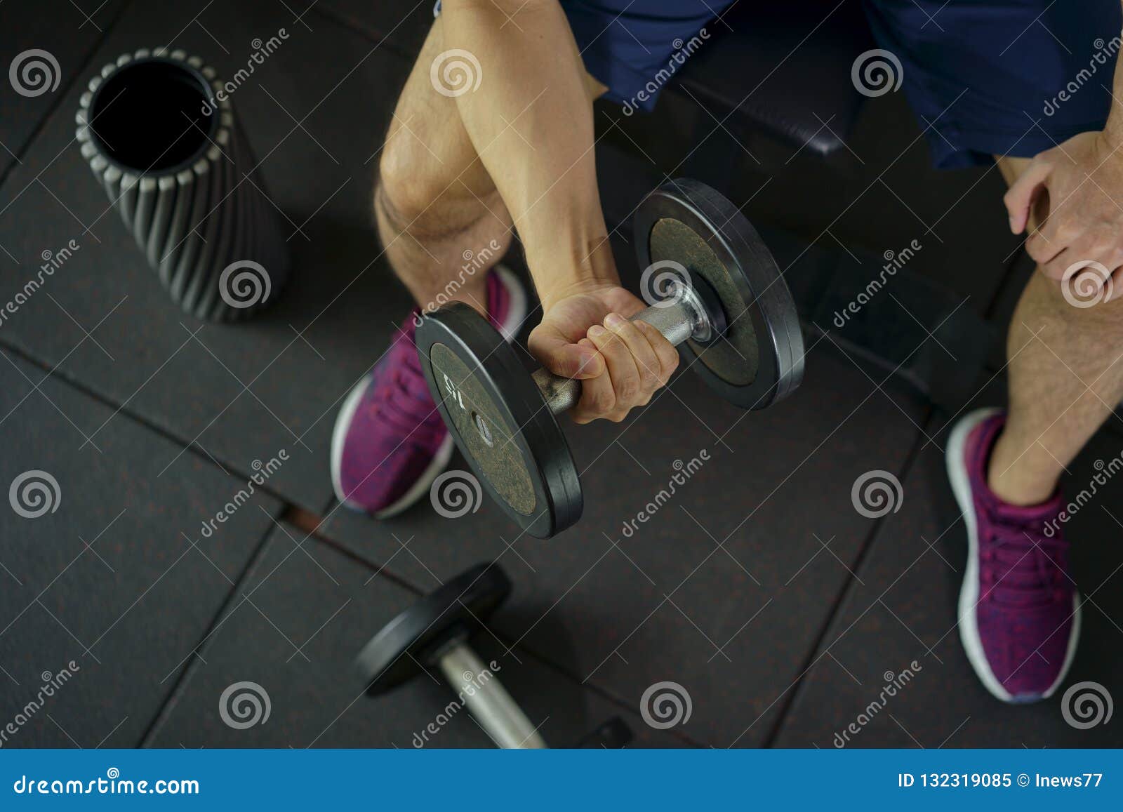 Strong Man Sitting and Workout Lifting Dumbbell for Exercise in Stock ...