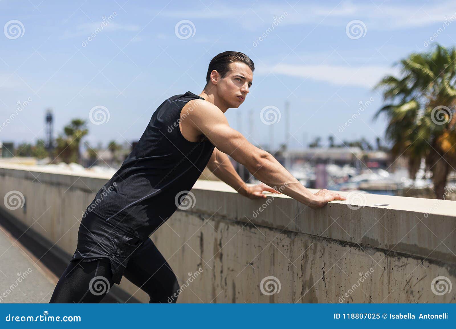 Sporty Man Stretching Calf and Leaning on a Wall Stock Image - Image of ...