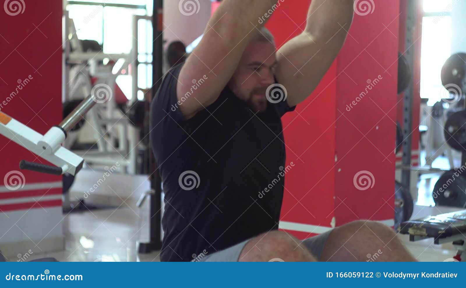 Strong Muscular Man Does Different Kind of Exercises in the Gym Stock ...