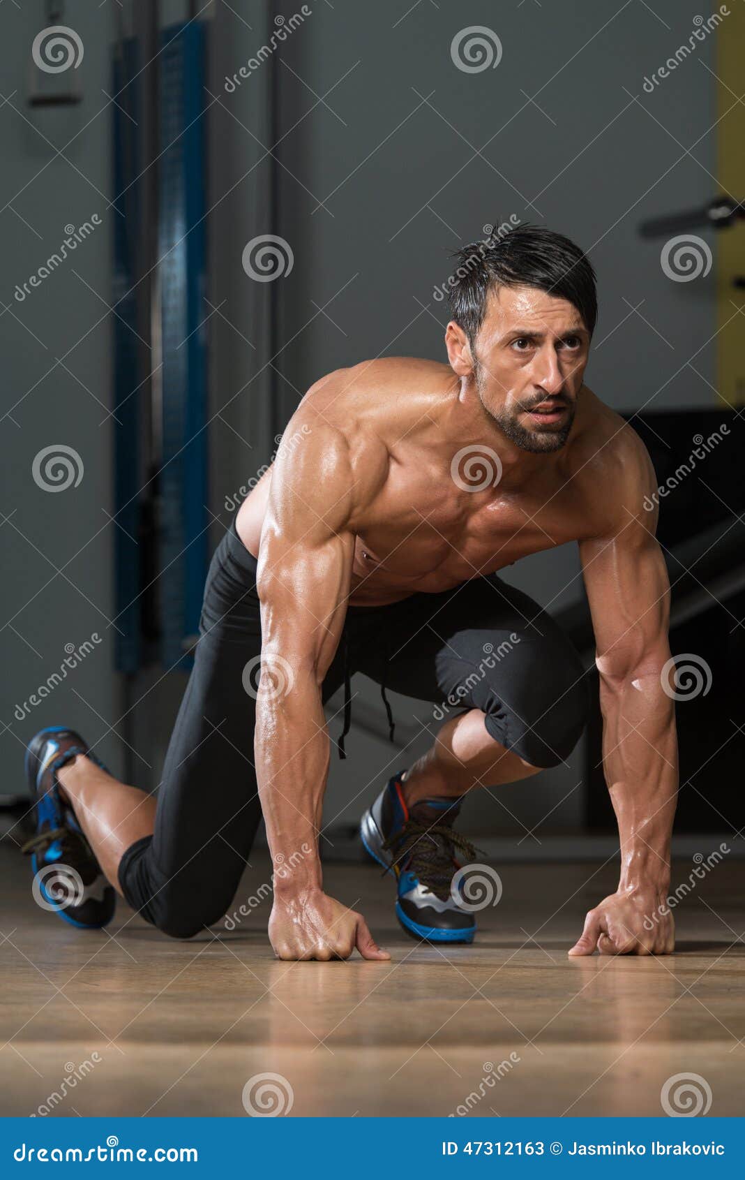 Strong Muscular Men Kneeling on the Floor Stock Image - Image of ...