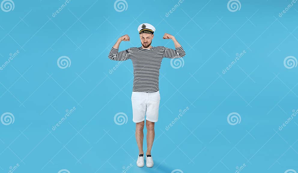 Strong Sailor Showing Biceps on Light Blue Background Stock Photo ...