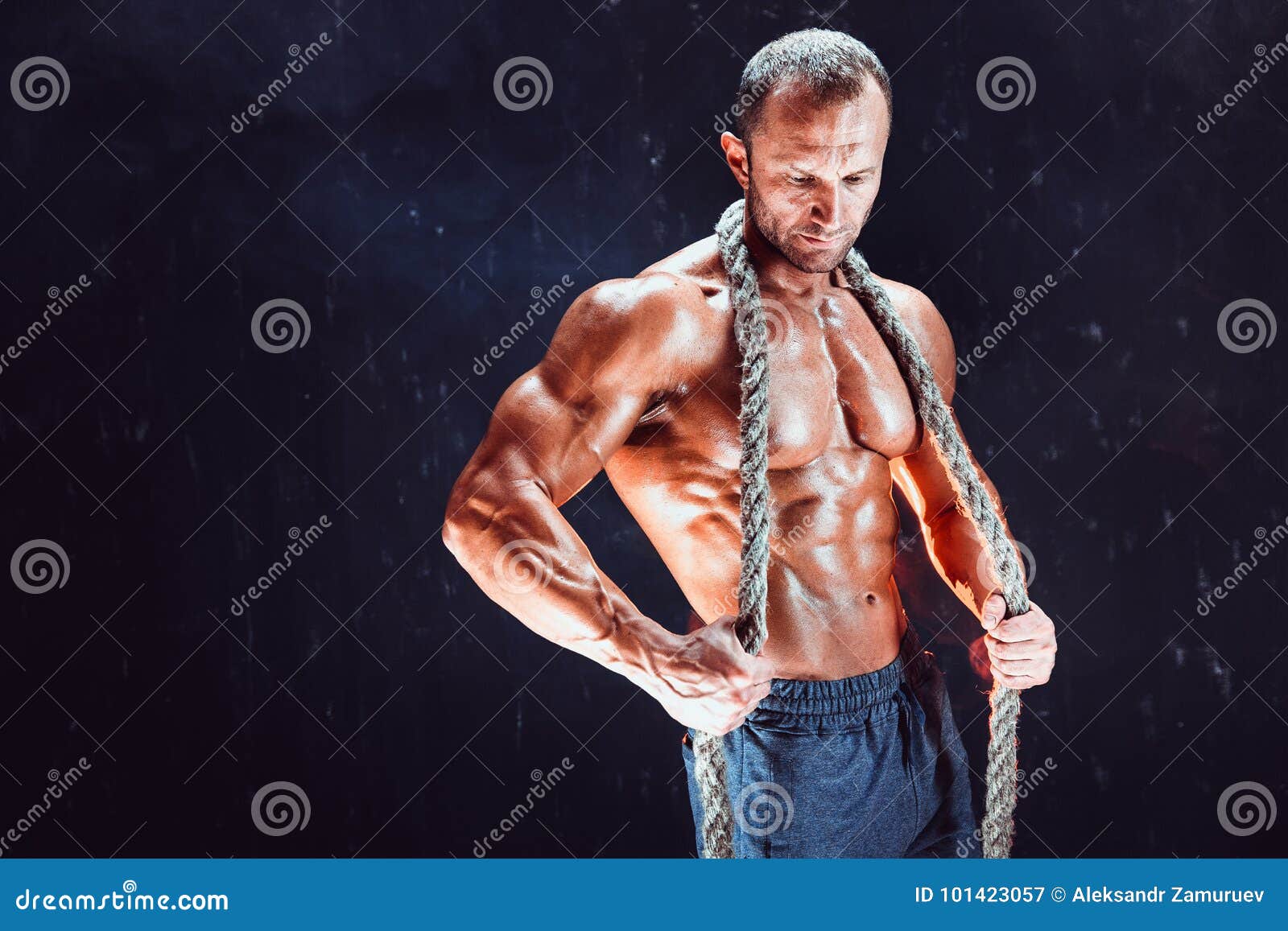 Strong man with rope stock image. Image of bodybuilder - 101423057