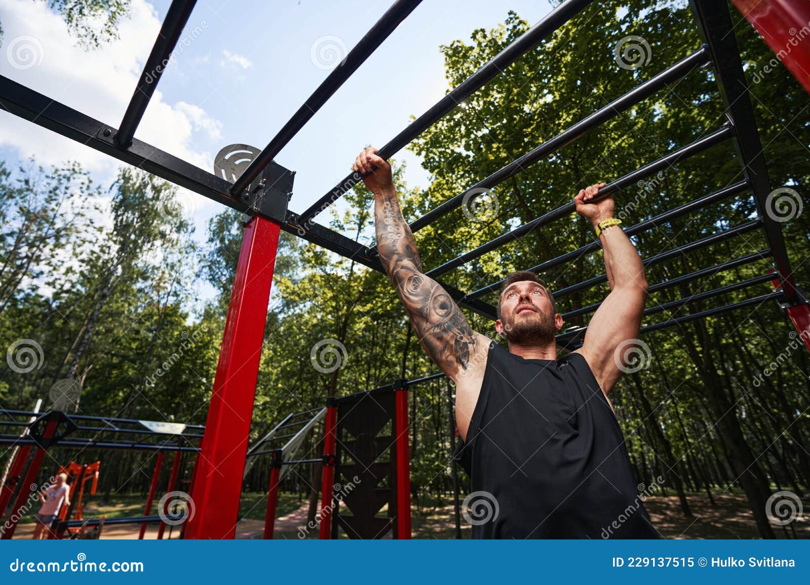 Strong Tattoed Male Exercising on Parallel Ladder Stock Image - Image ...