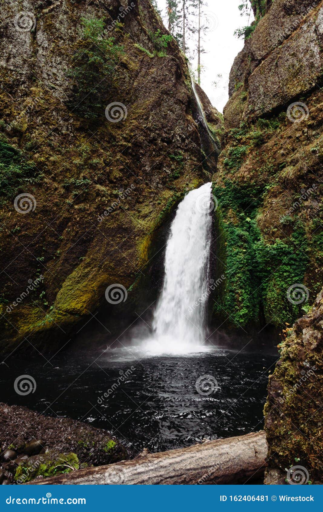 Strong Waterfall Falling from the Middle of Enormous Rocks and Flowing ...