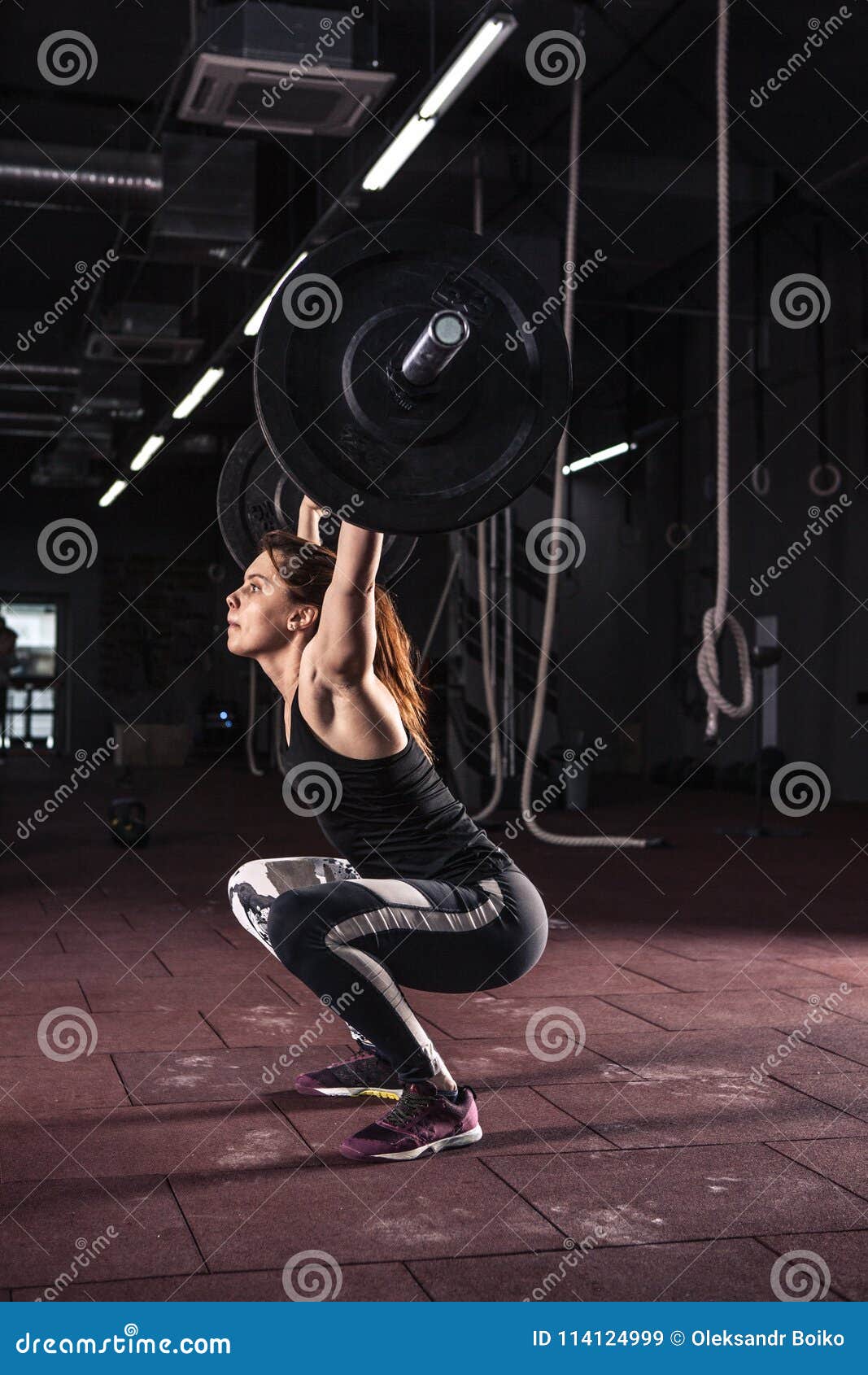 Strong Woman Lifting Barbell As A Part Of Crossfit Exercise Rout Stock