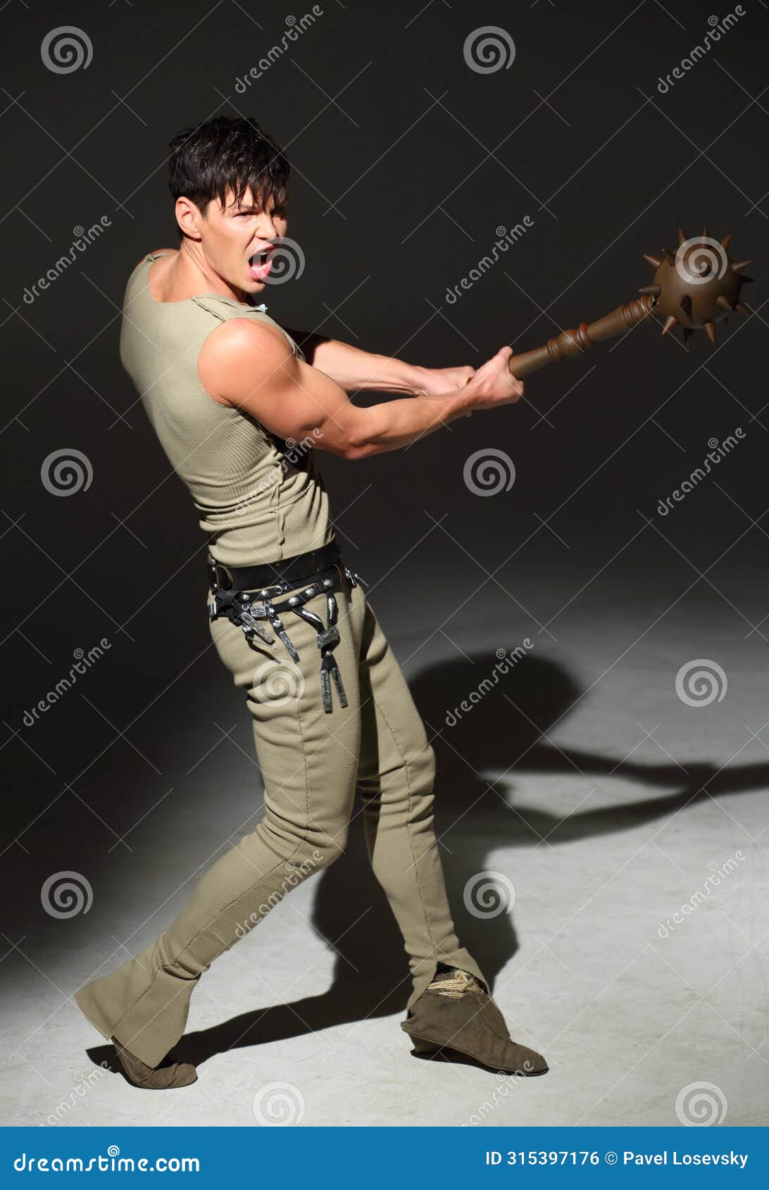 Strong Young Man in a Costume Stock Photo - Image of body, indoors ...