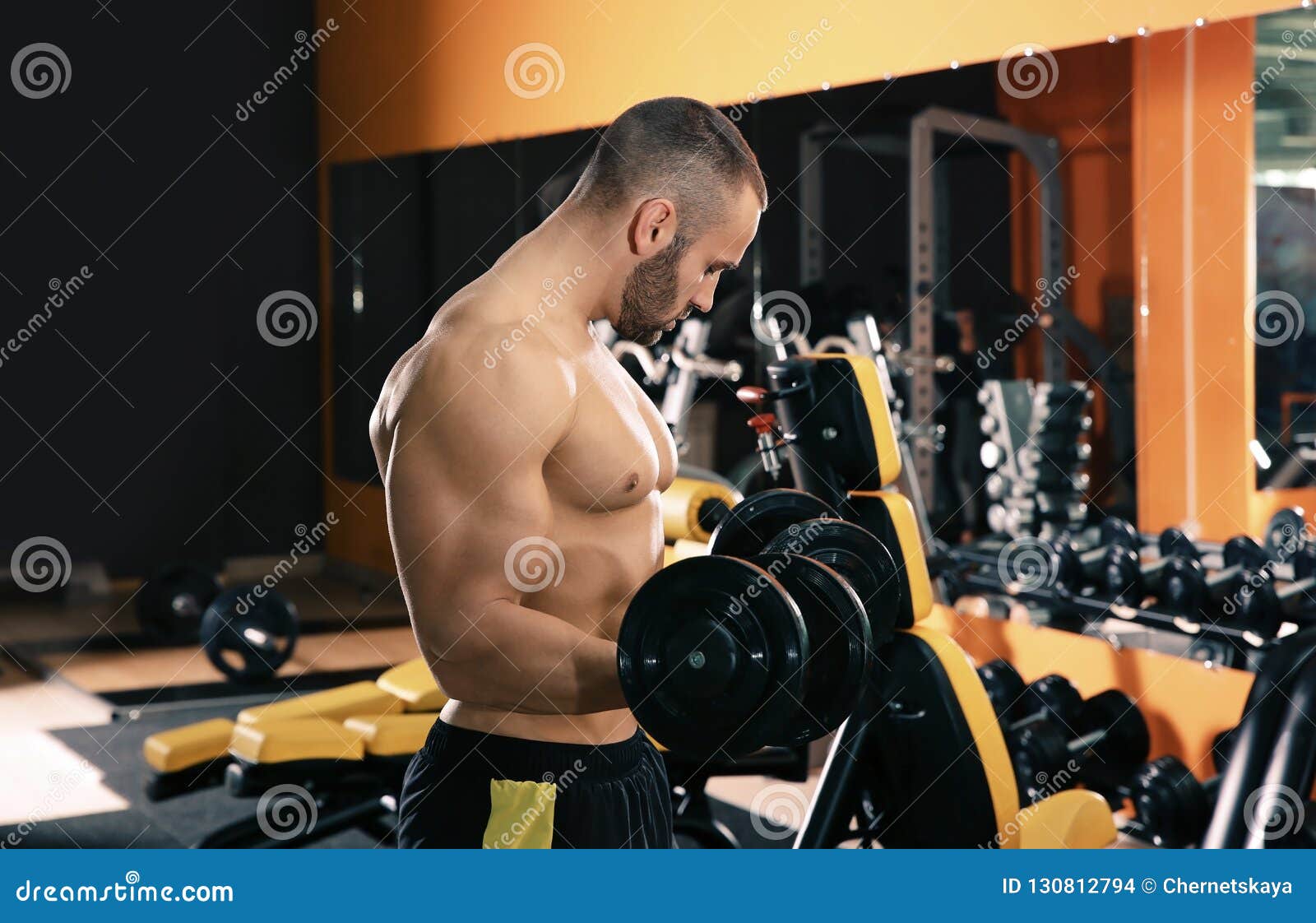 Strong Young Man Lifting Dumbbells Stock Photo - Image of adult ...
