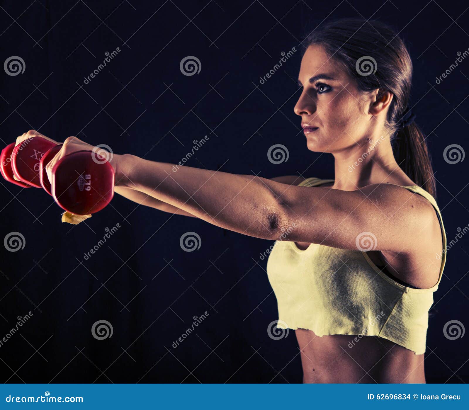 Strong Young Woman Doing Dumbbell Front Raises Stock Photo - Image of ...