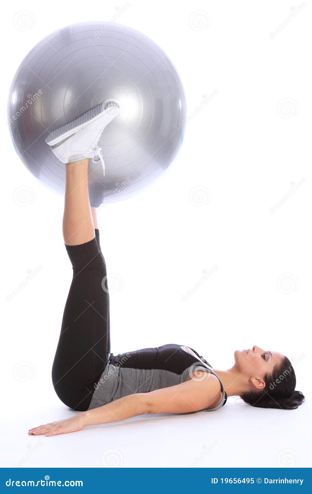 Strong Young Woman Exercising Legs with Ball Stock Image - Image of ...