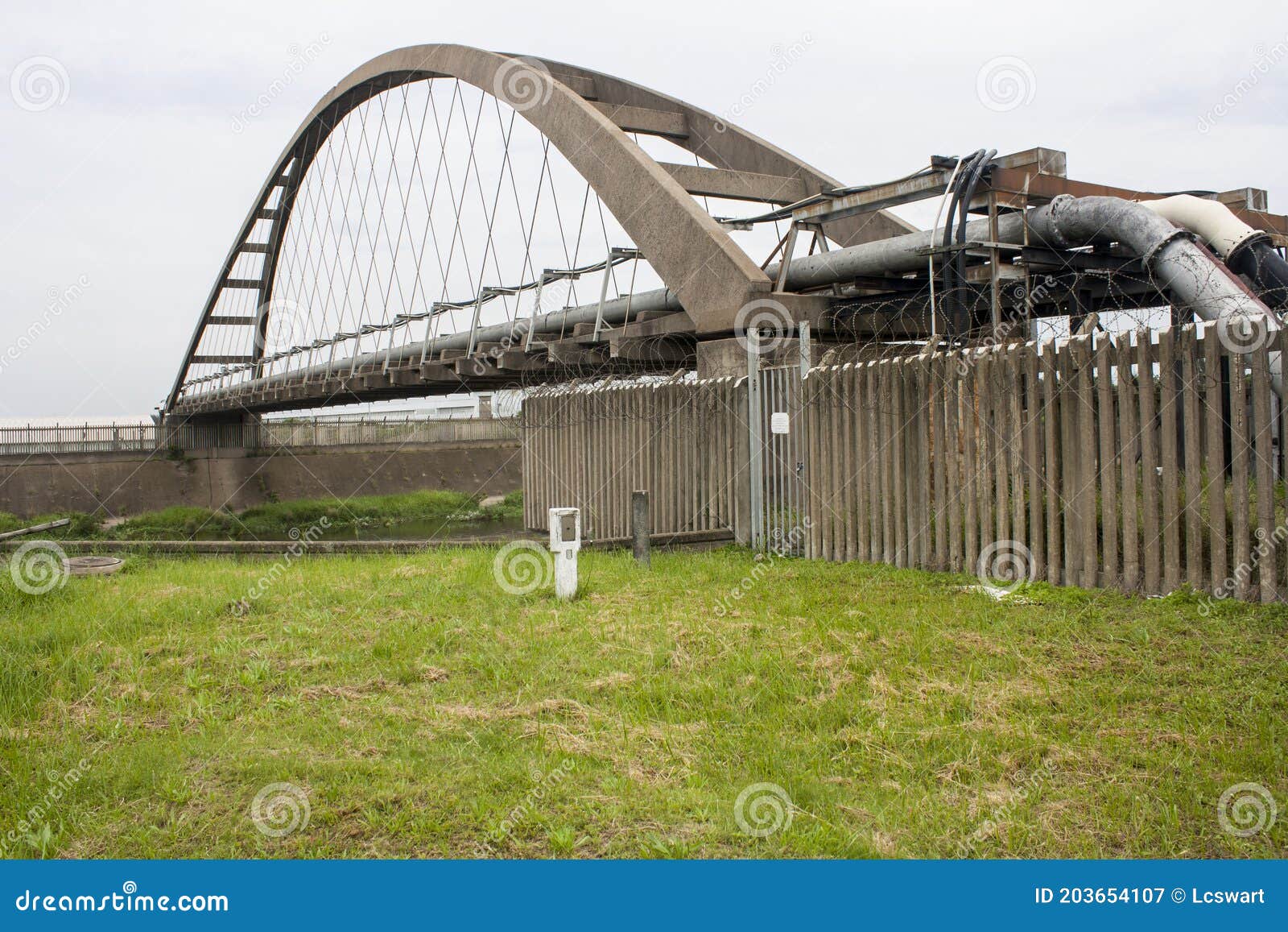 Arched Bridge Carrying Pipes Across Wide Canal Stock Image - Image of ...