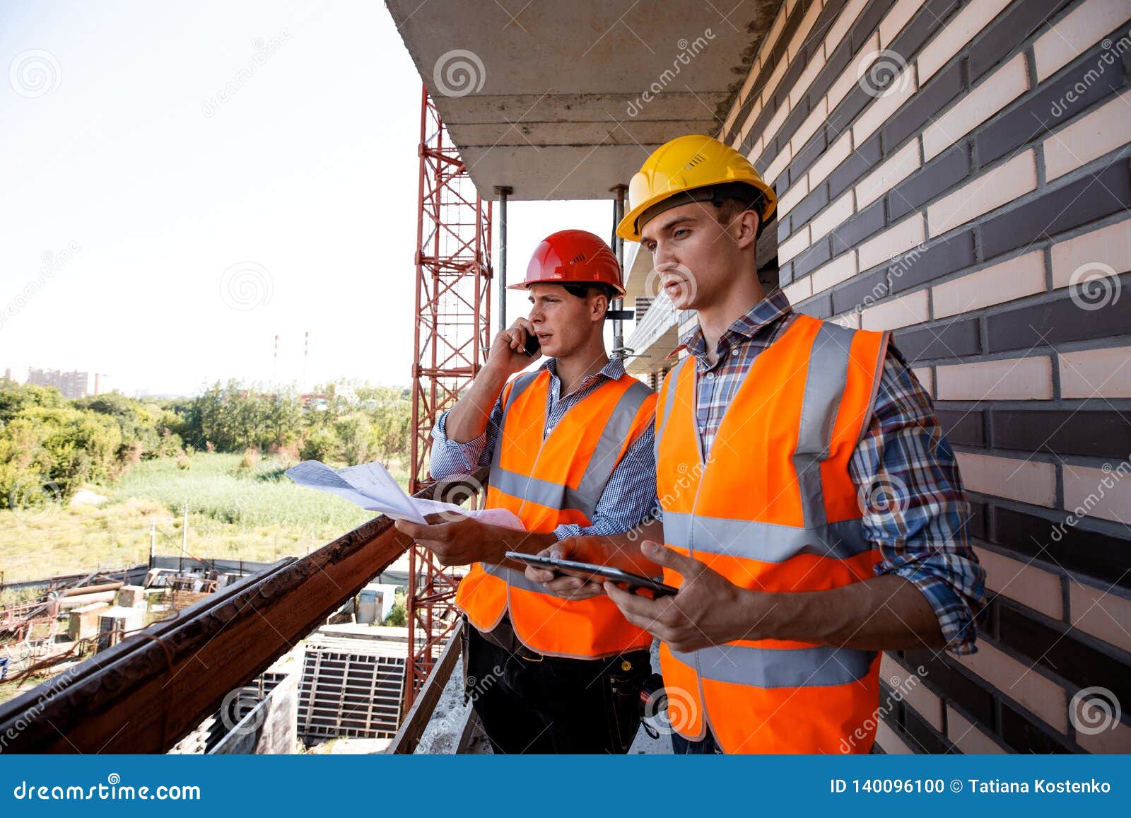 Structural Engineer and Architect Dressed in Orange Work Vests and ...