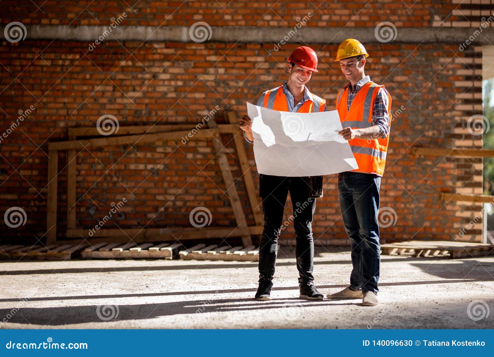 Structural Engineer and Architect Dressed in Orange Work Vests and ...