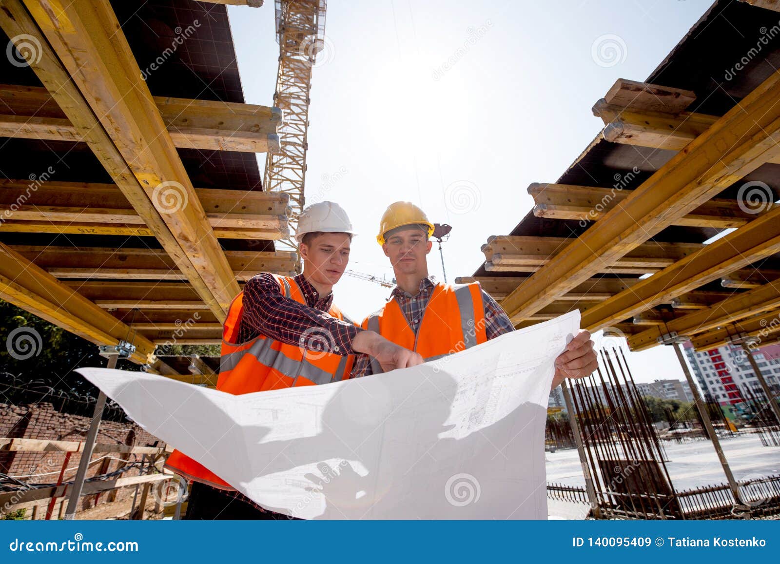 Structural Engineer and Architect Dressed in Shirts, Orange Work Vests ...