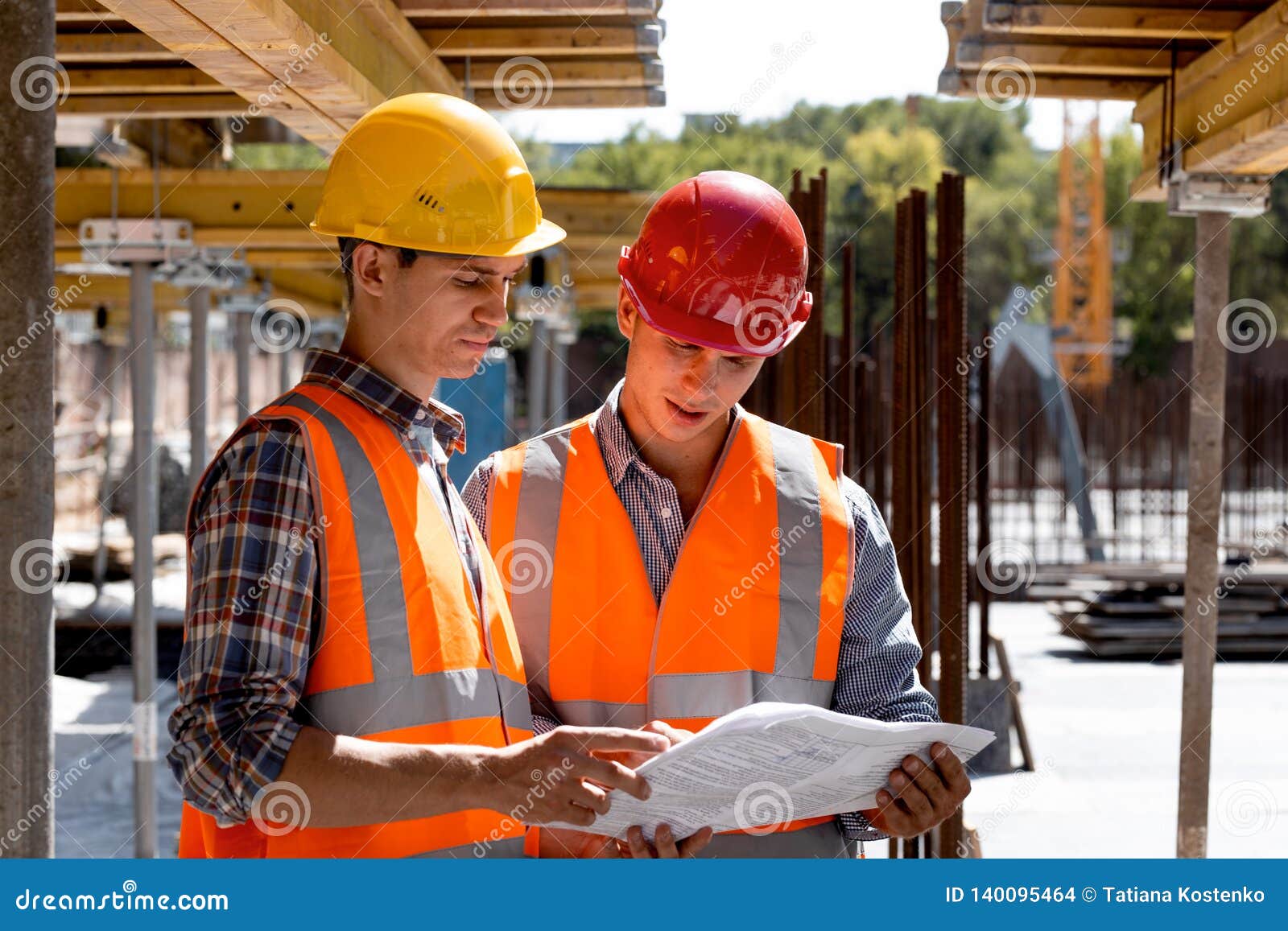Structural Engineer and Architect Dressed in Shirts, Orange Work Vests ...