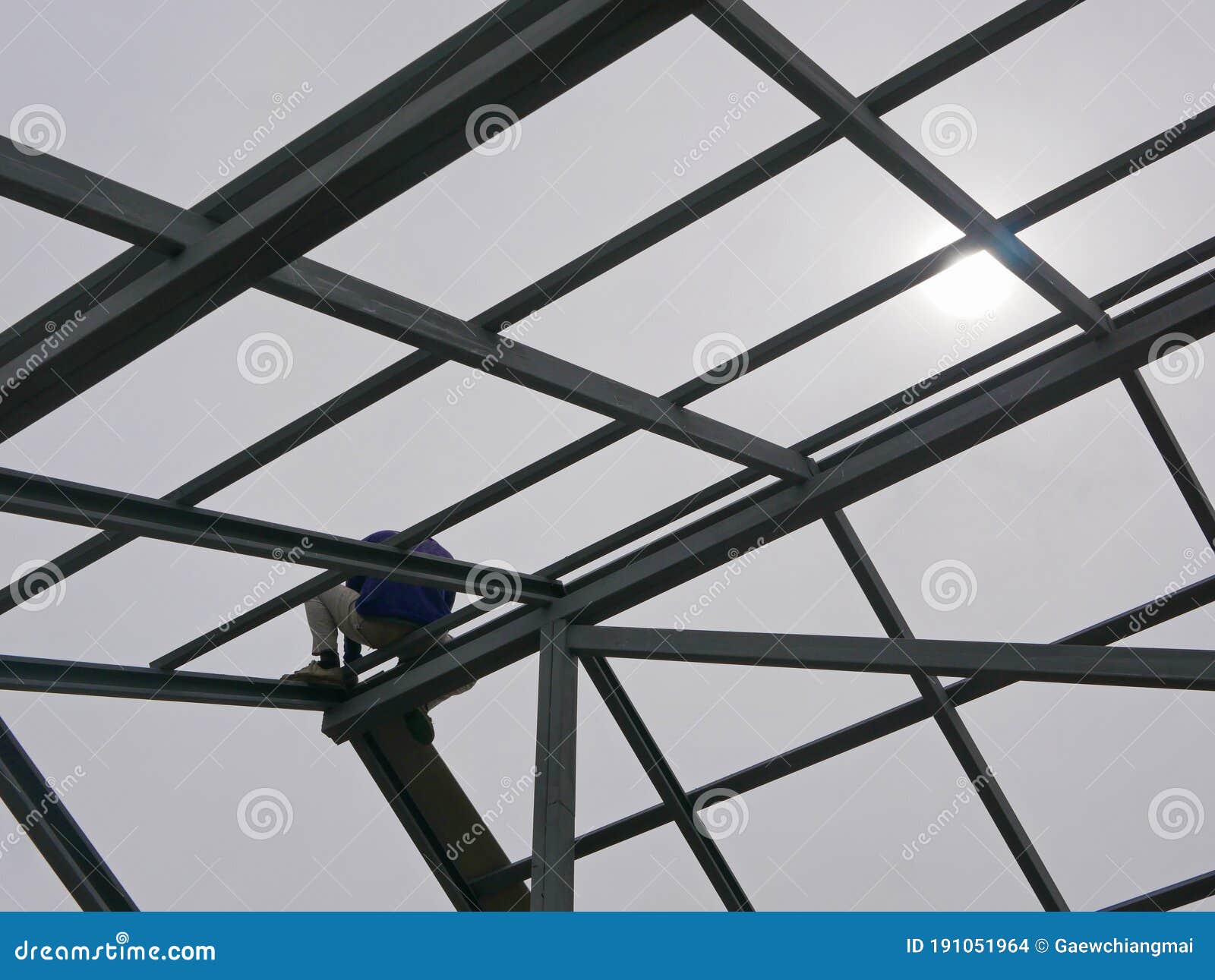 A Structural Steel Worker Working on a High Rooftop for a House Roof ...