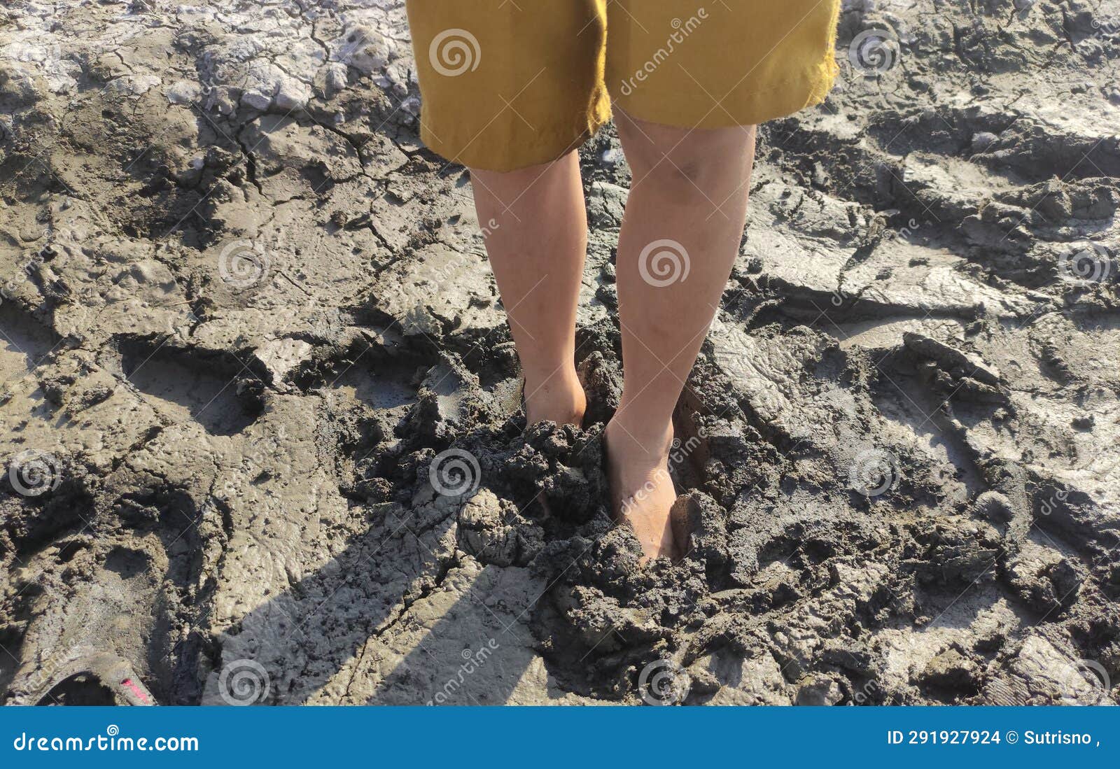 Stuck in the Mud. Close-up View of Feet Walking through Muddy Path ...