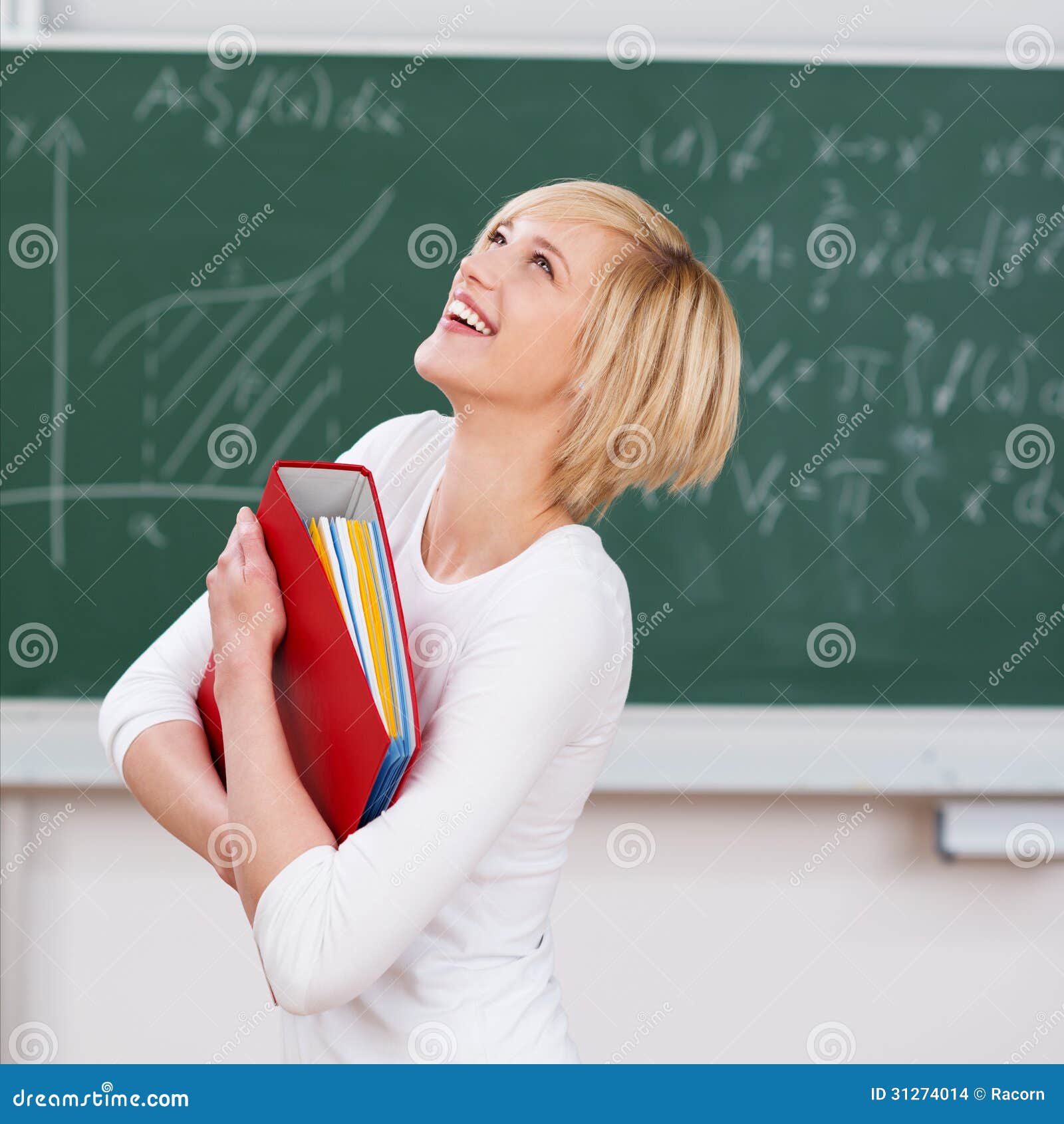 Student with Binder Looking Up Against Chalkboard Stock Photo - Image ...