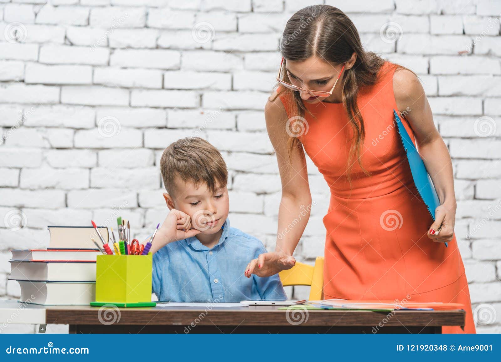Student Boy Doing Work in School Supervised by His Teacher Stock Photo ...