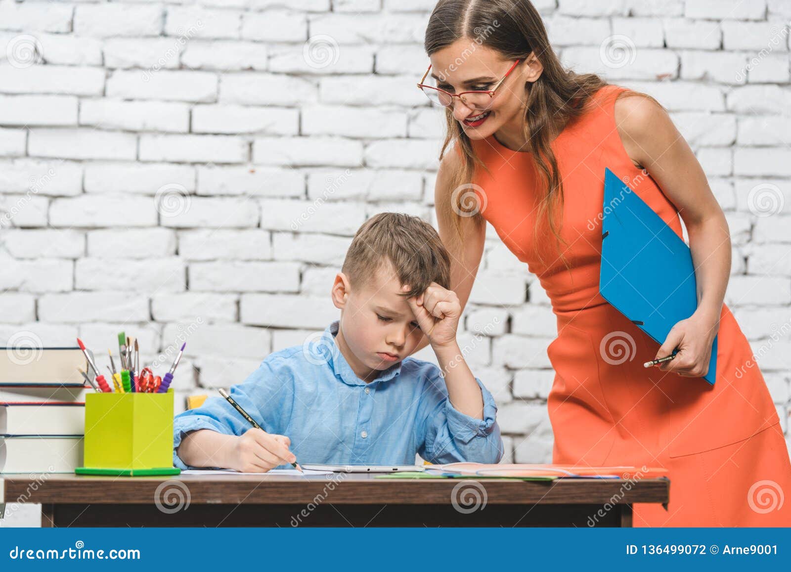 Student Boy Doing Work in School Supervised by His Teacher Stock Photo ...