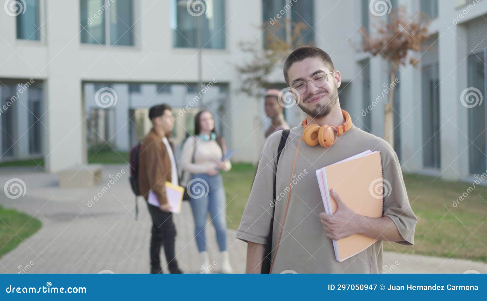 Student Boy Looking at Camera while His Friends are Behind Talking, in ...