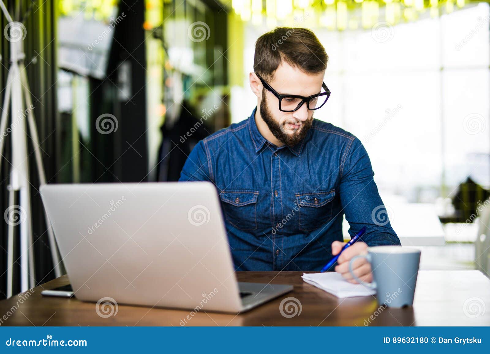 Student Busy Taking Notes Down from His New Laptop Computer while ...
