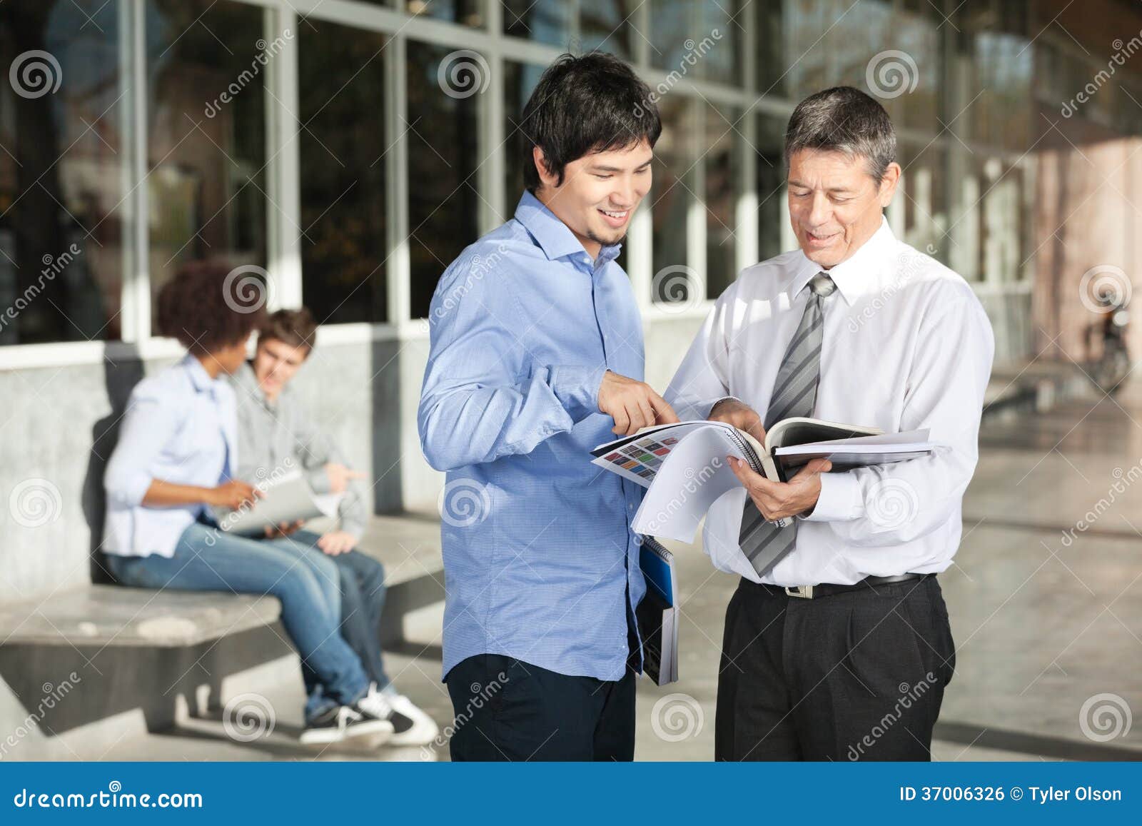 Student on Campus Professor-with Books Explaining Stockfoto - Bild von ...