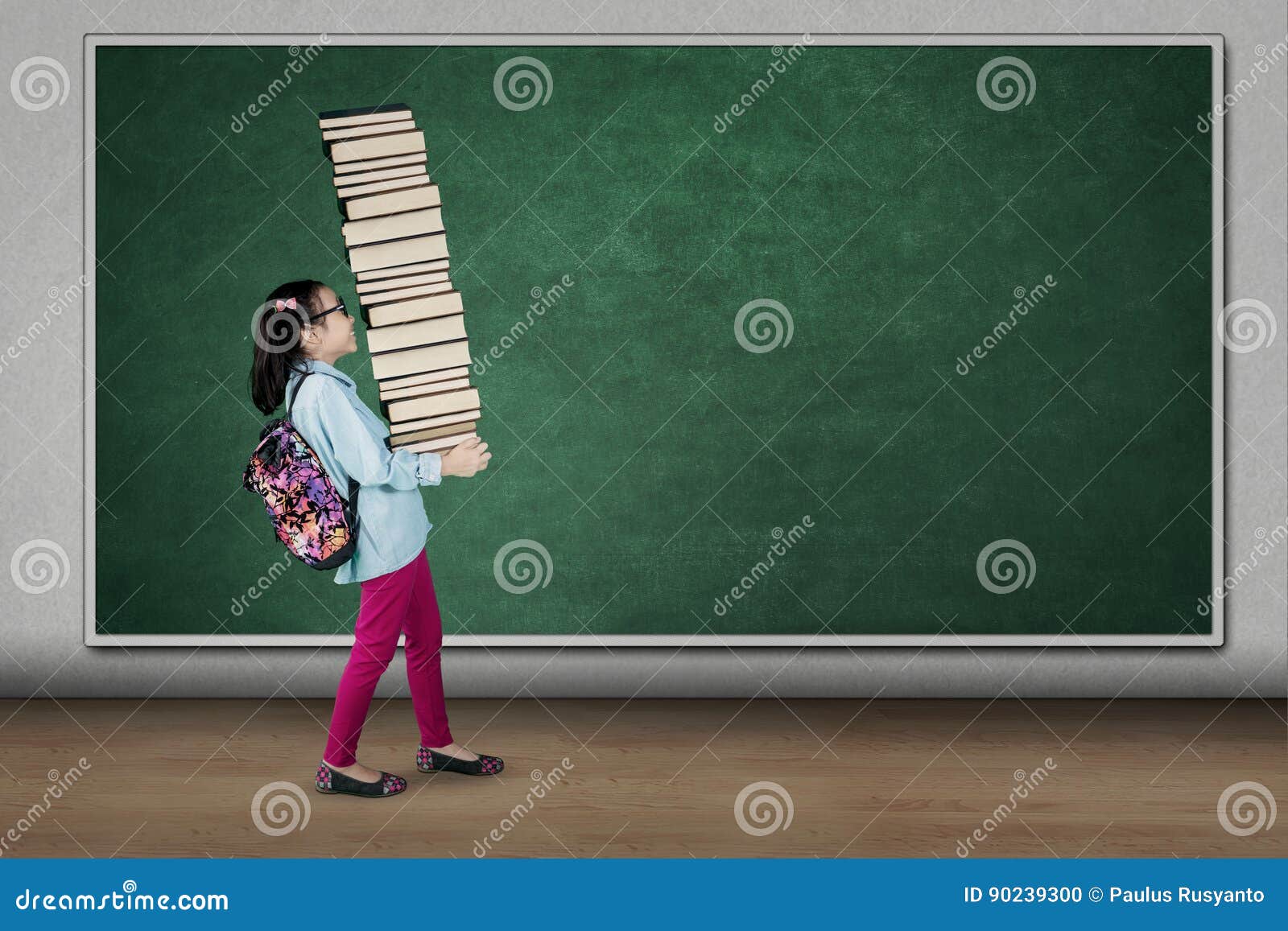 Student Carrying Stack of Books in Classroom Stock Photo - Image of ...