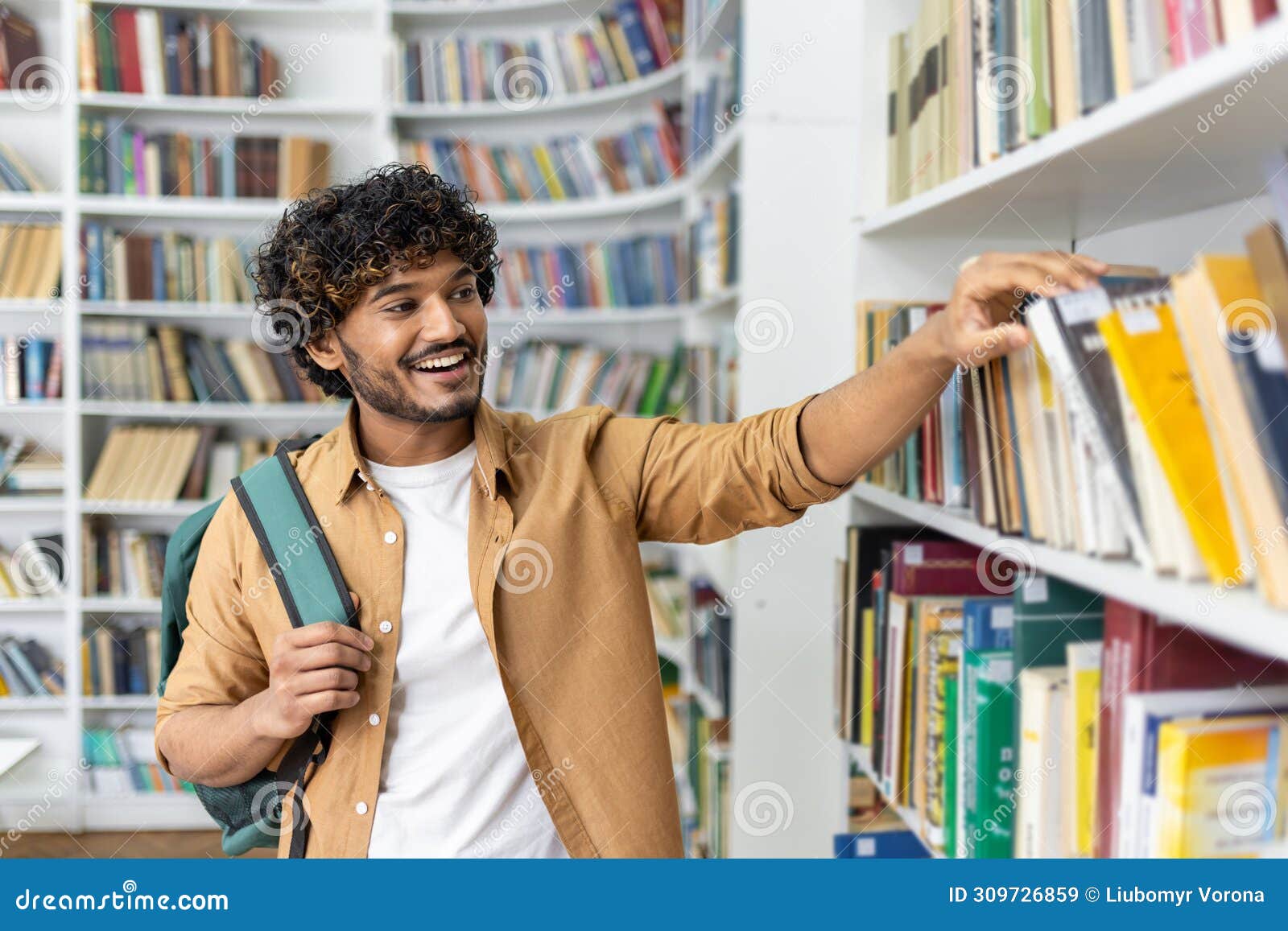 Student Choosing Book from Library Shelf for Education and Learning ...