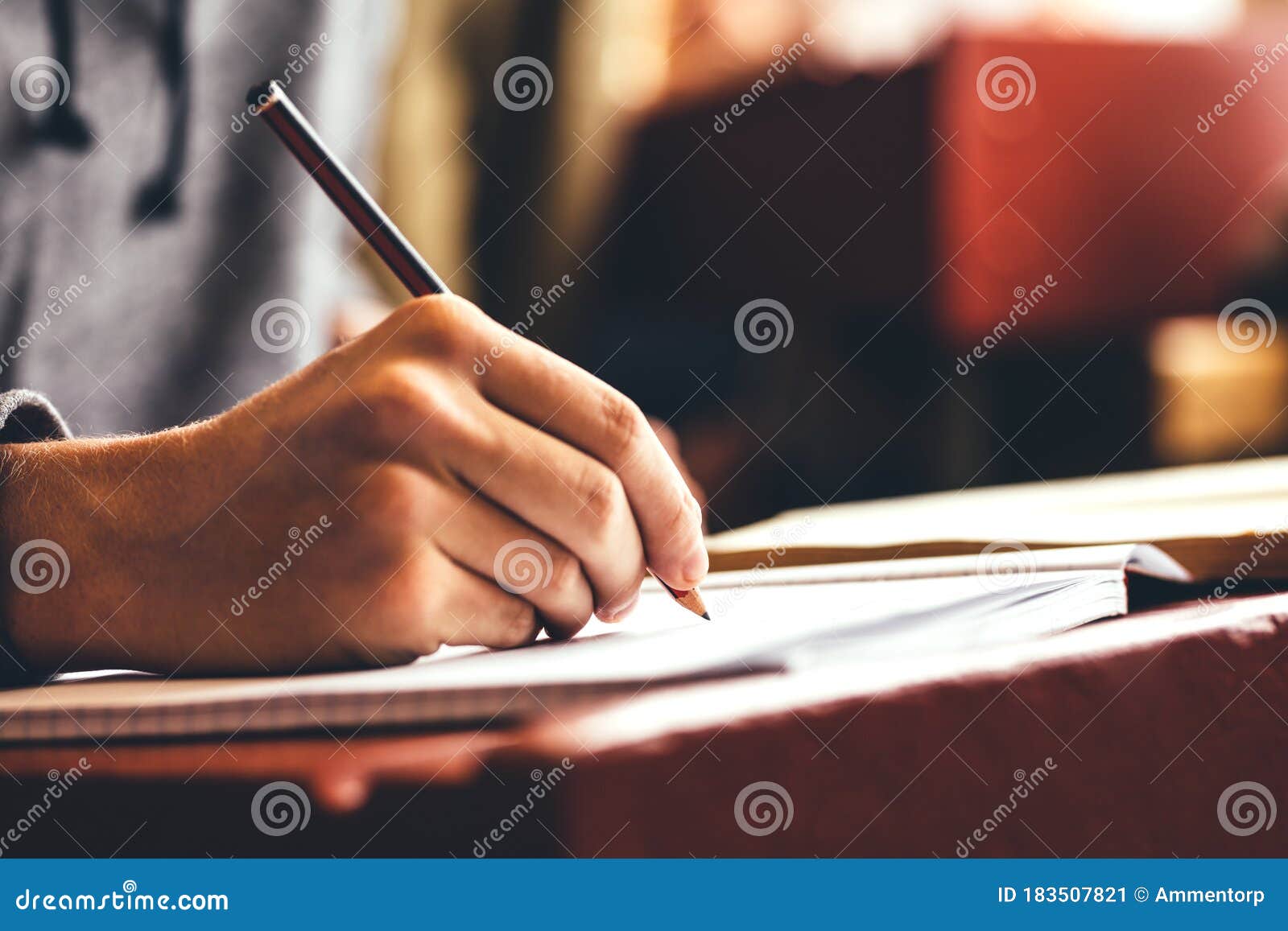 Student in Classroom Writing in a Notebook Stock Image - Image of ...