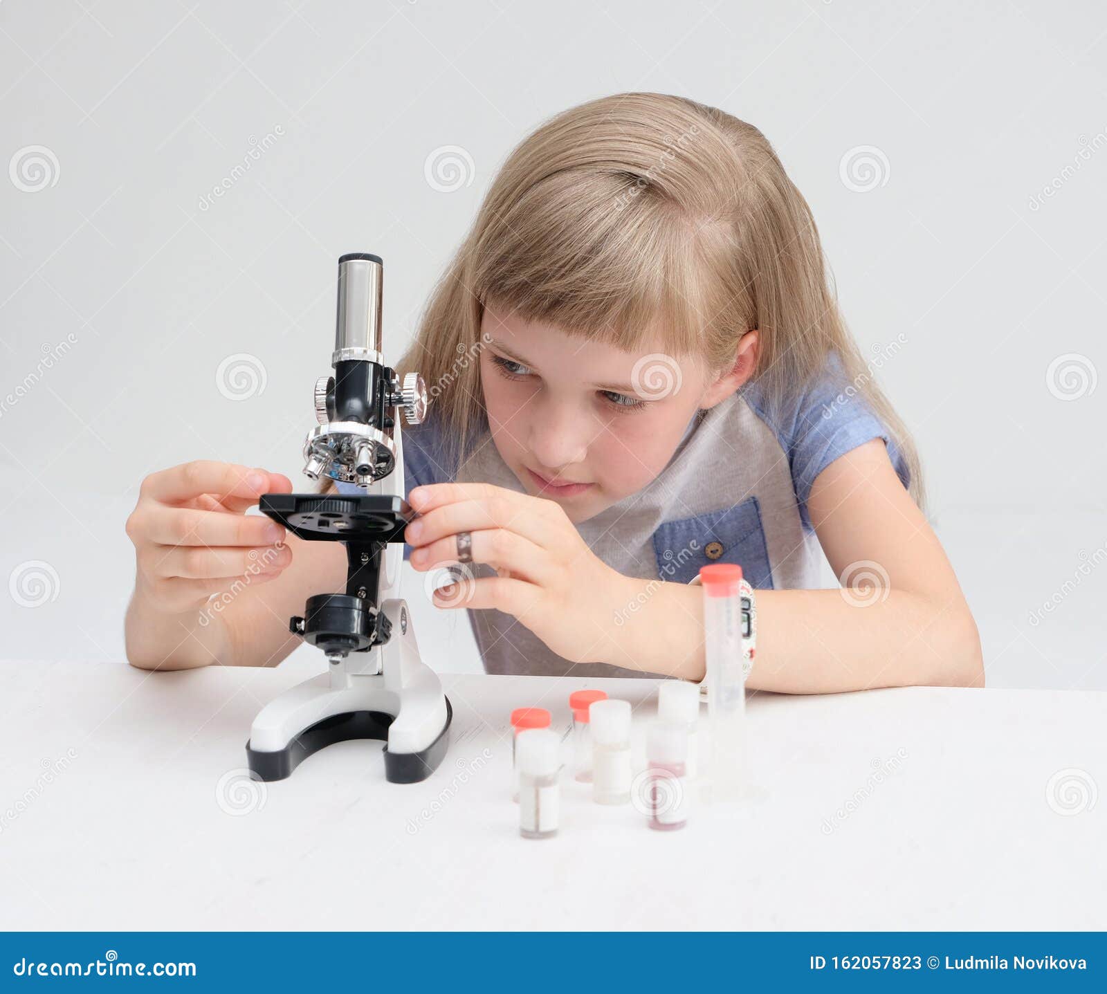 The Student Conducts an Experiment with a Microscope Stock Image ...