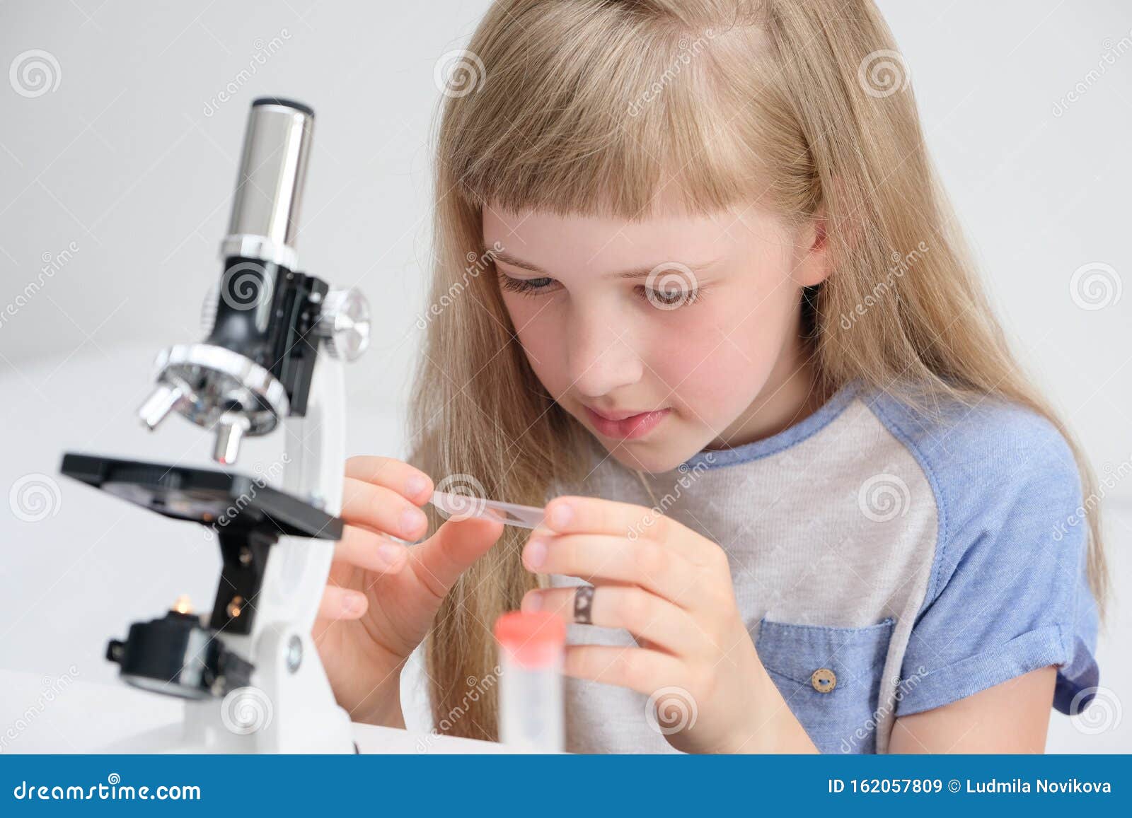 The Student Conducts an Experiment with a Microscope Stock Image ...
