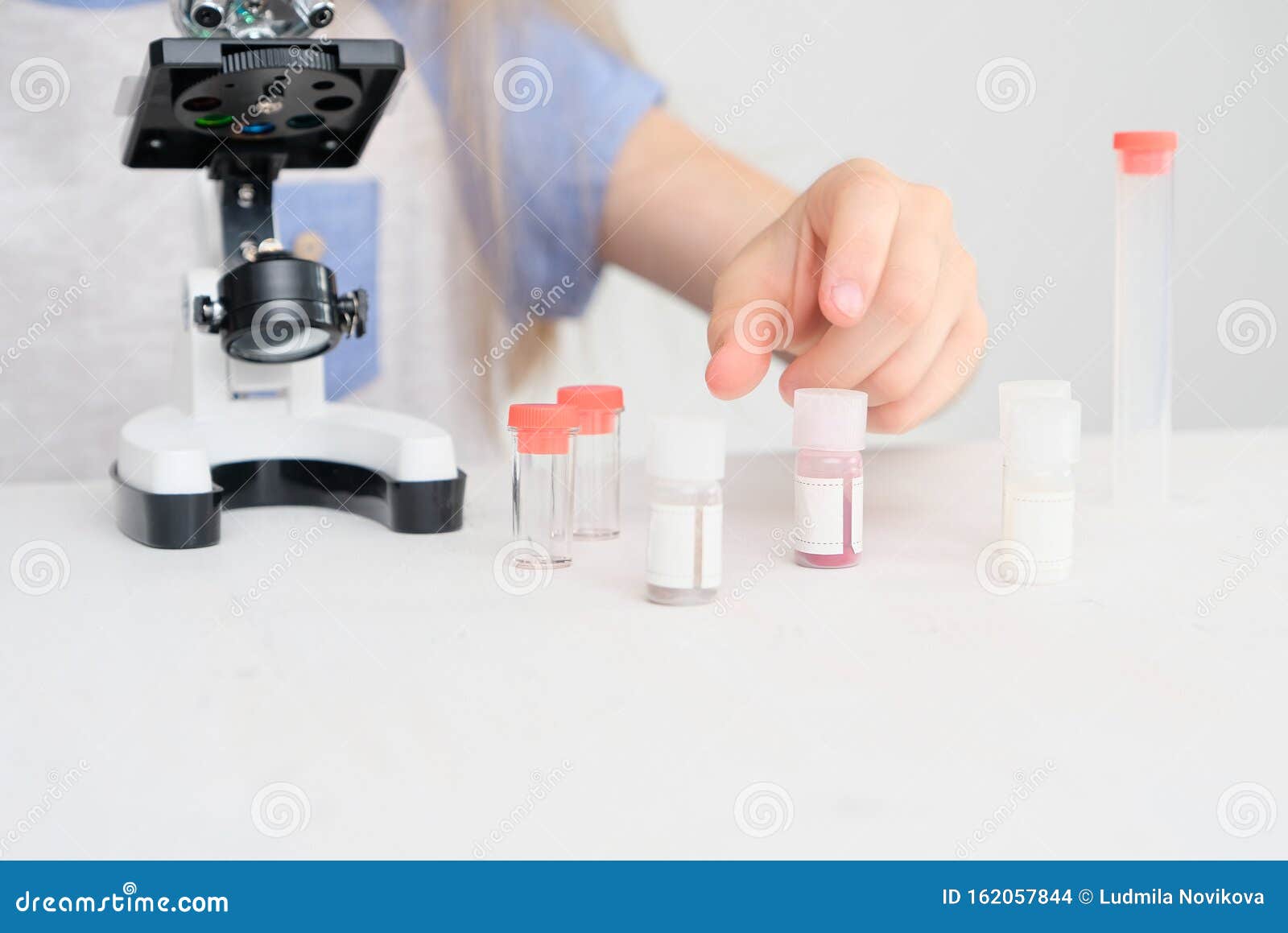 The Student Conducts an Experiment with a Microscope Stock Photo ...