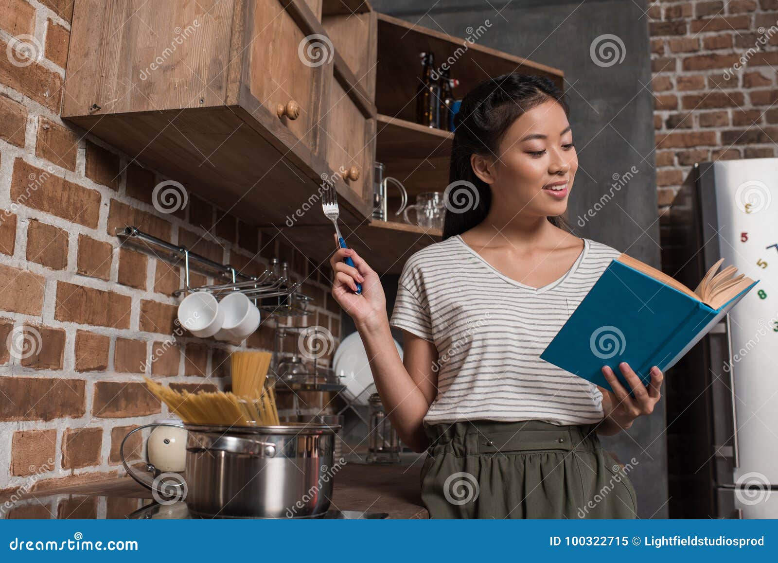 Student Cooking and Reading Book Stock Image - Image of smiling, people ...