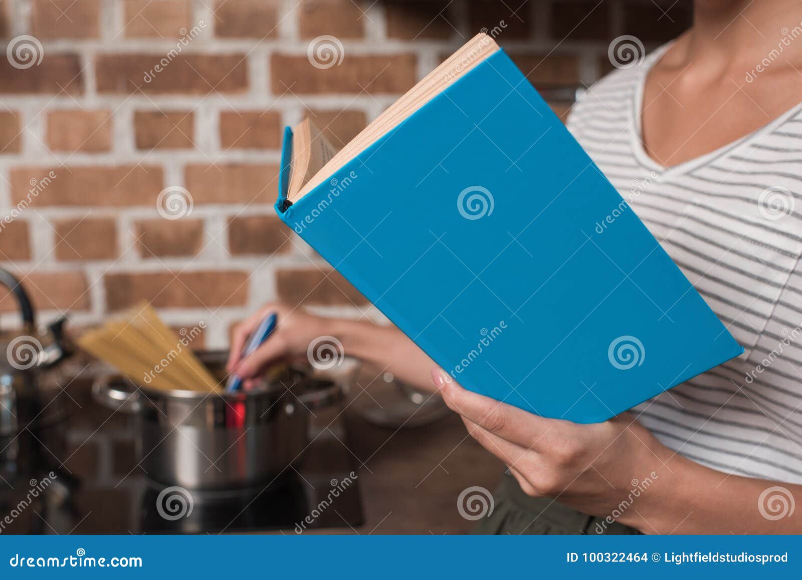 Student Cooking and Reading Book Stock Photo - Image of woman, studying ...