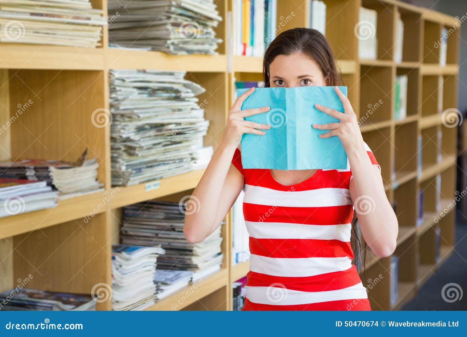 Student Covering Face with Book in Library Stock Photo - Image of ...