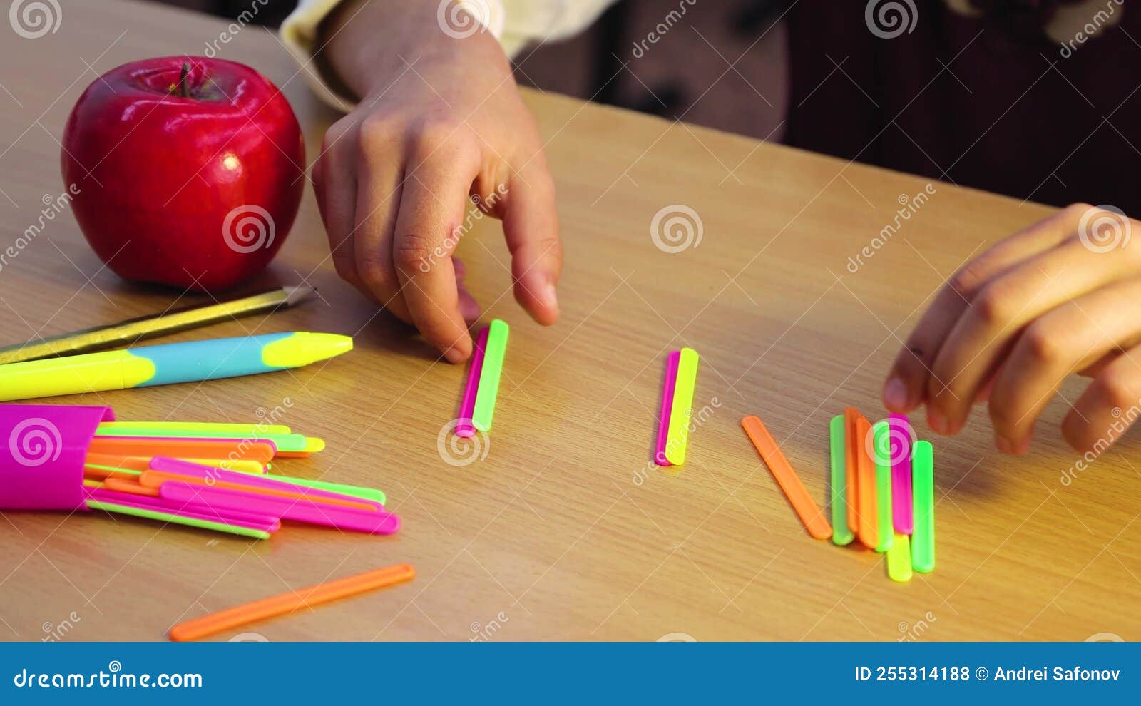 A Student at a Desk is Studying Math with the Help of Multi-colored ...