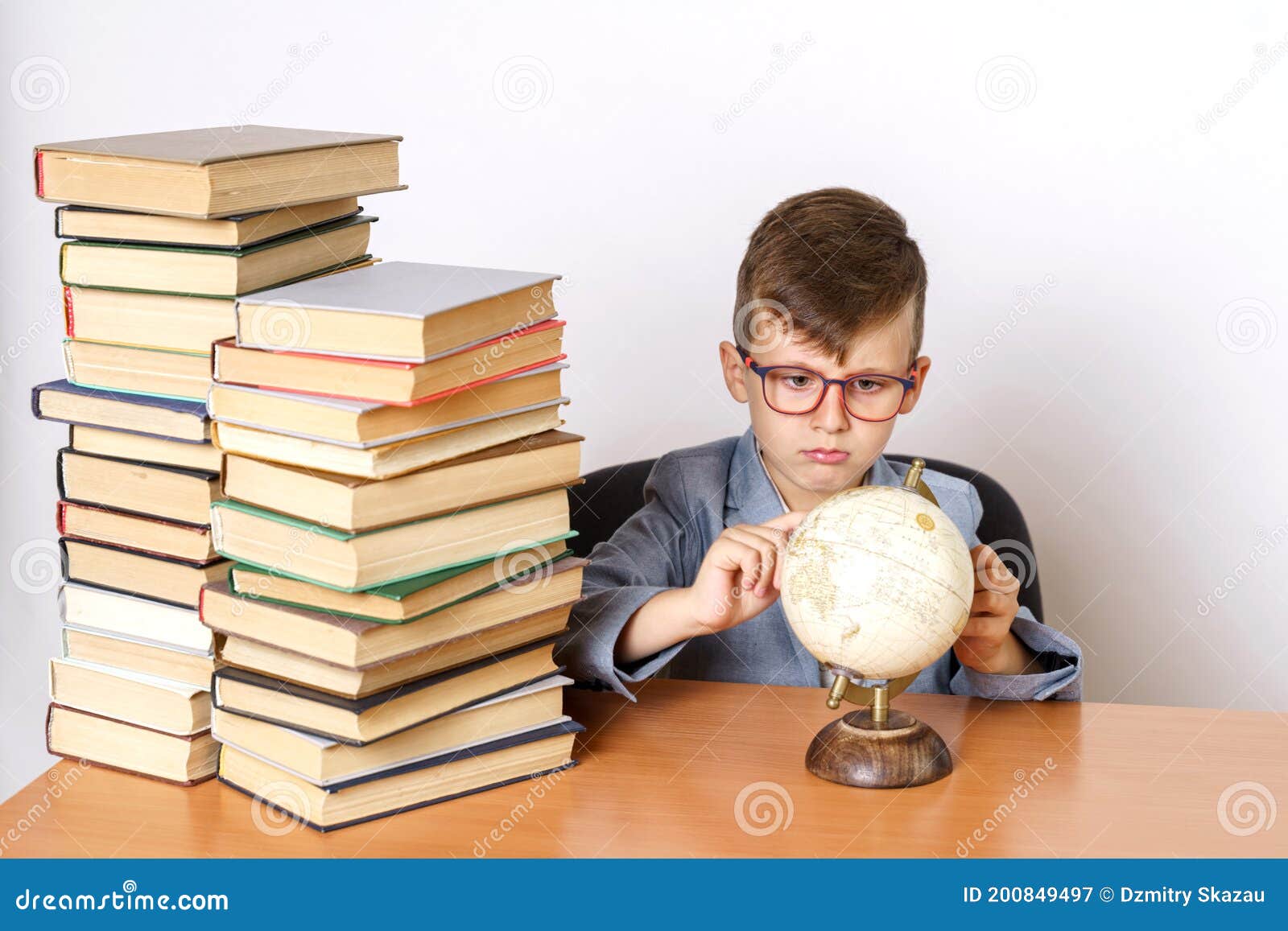 The Student Does Homework, Studies the Globe. he Has Books on Both ...