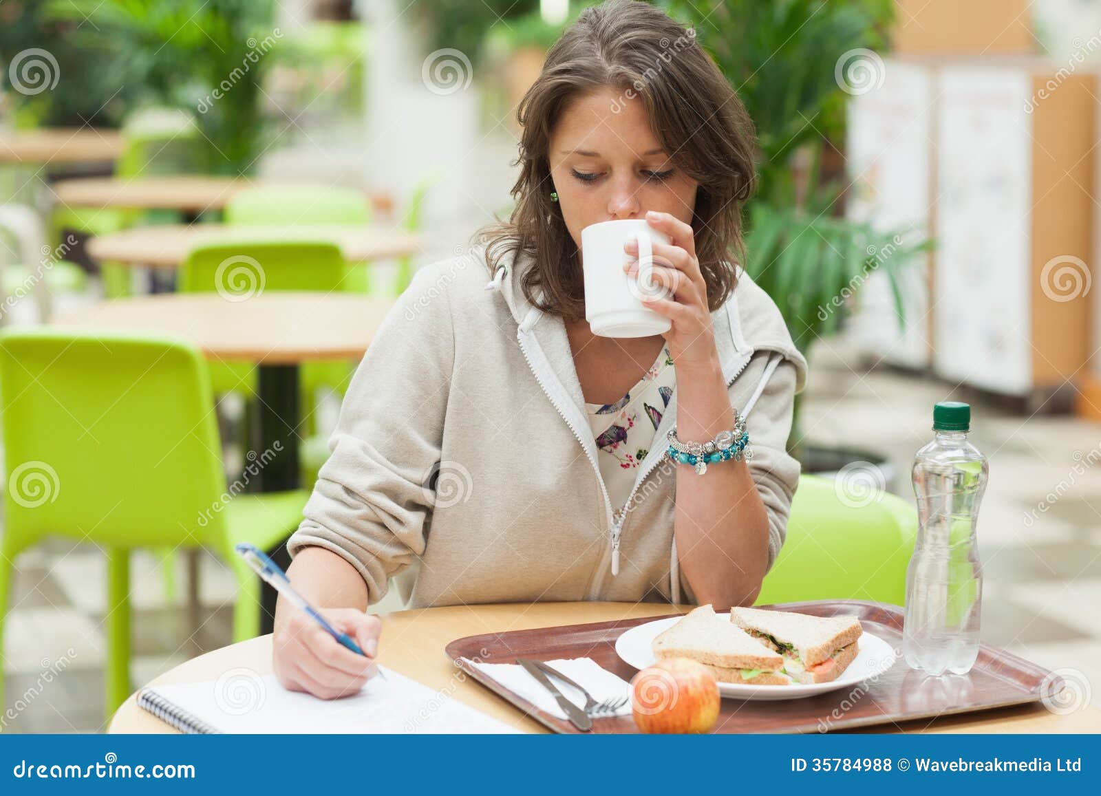 Student Doing Homework and Having Breakfast in Cafeteria Stock Photo ...