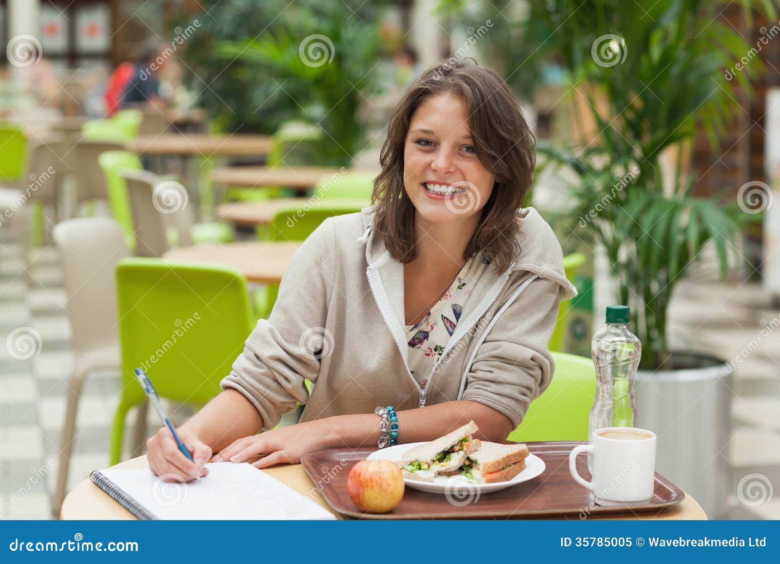 Student Doing Homework while Having Breakfast in the Cafeteria Stock ...