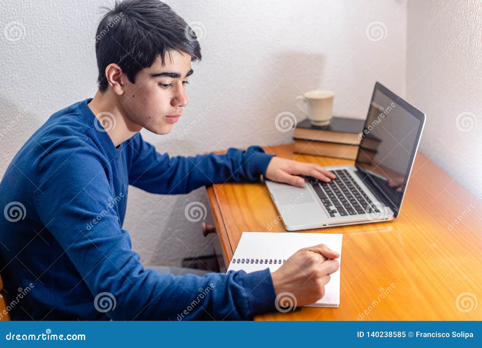 Student Doing Homework at His Desk with Laptop Stock Image - Image of ...