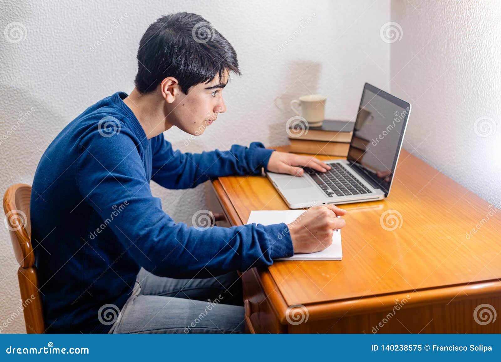 Student Doing Homework at His Desk with Laptop Stock Image - Image of ...