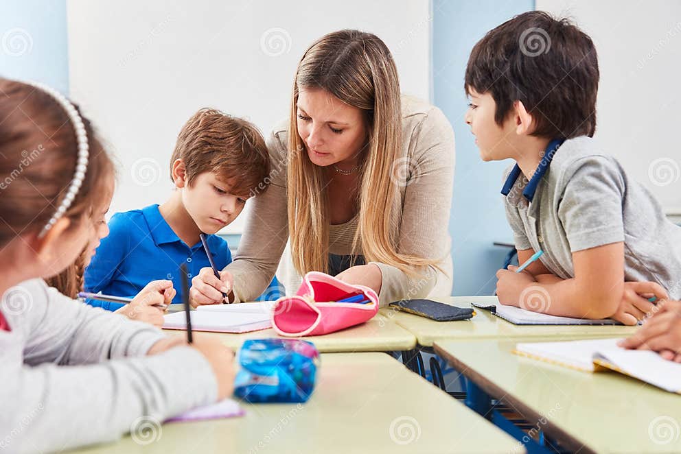 Student Doing Homework Tutoring in Elementary School Stock Photo ...