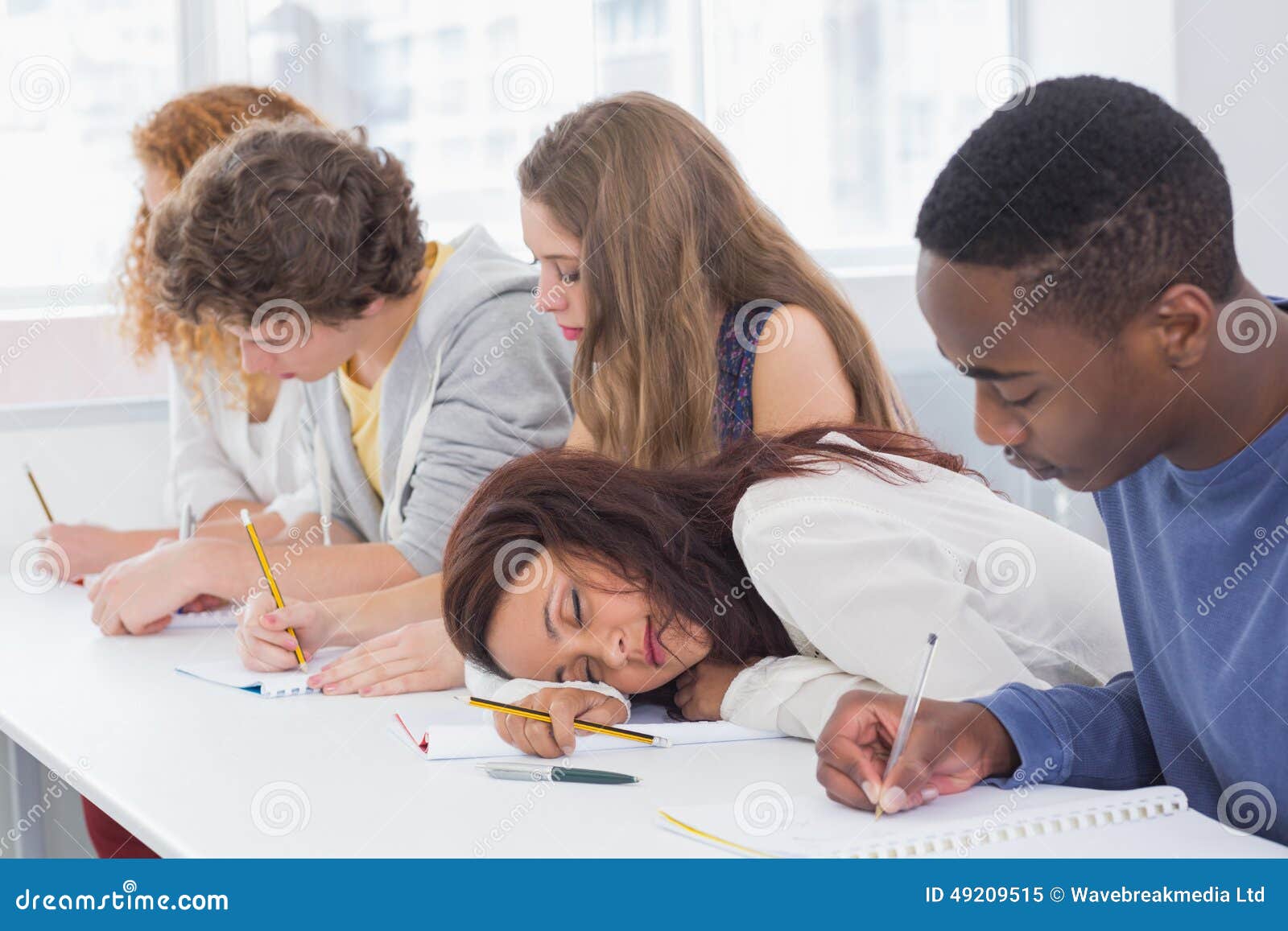 Dozing Student Sitting On Library Floor Leaning On Pile Of Books ...